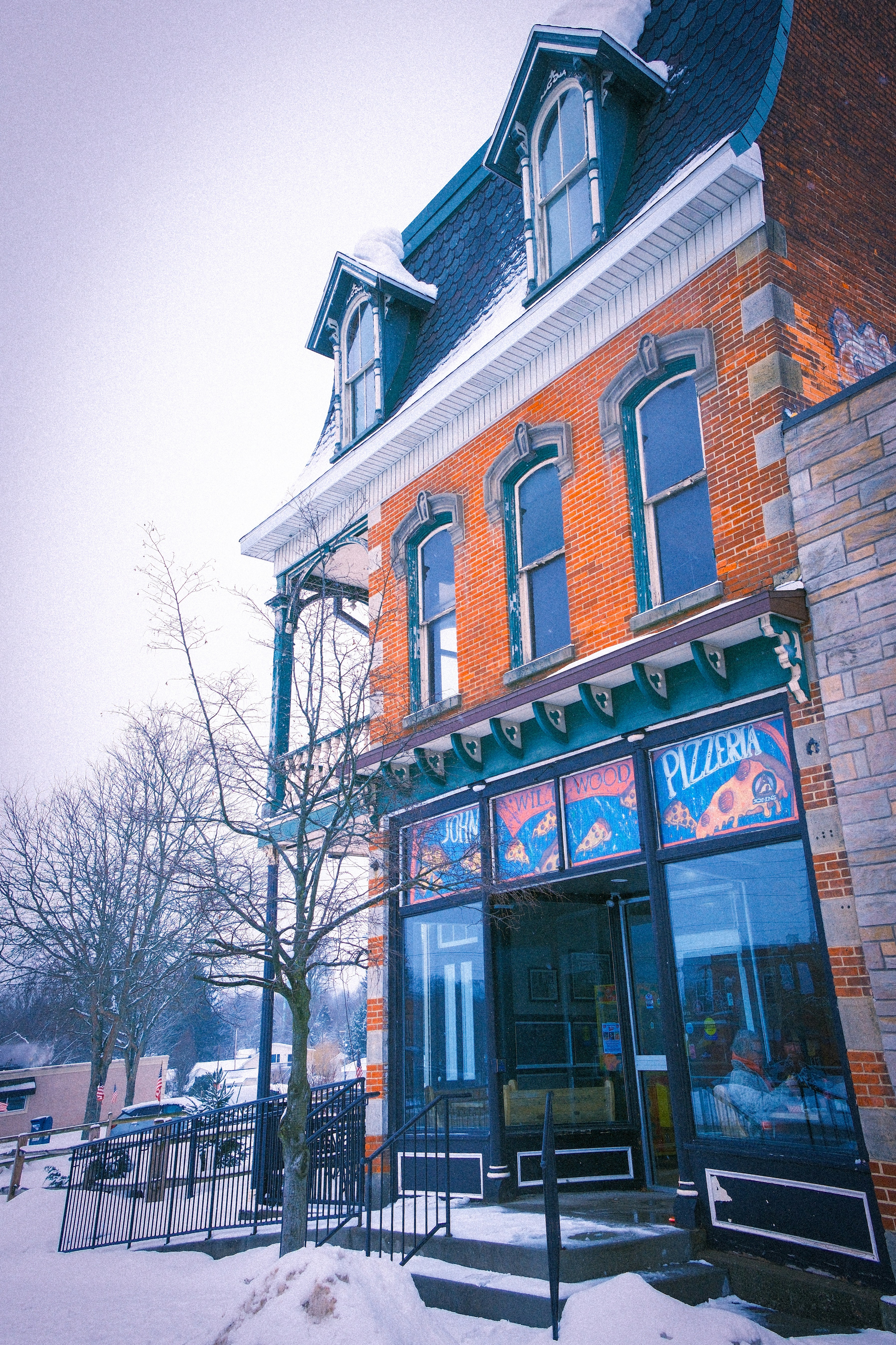 Brick-Walled Pizzeria Beneath Snow-Dusted Dormers