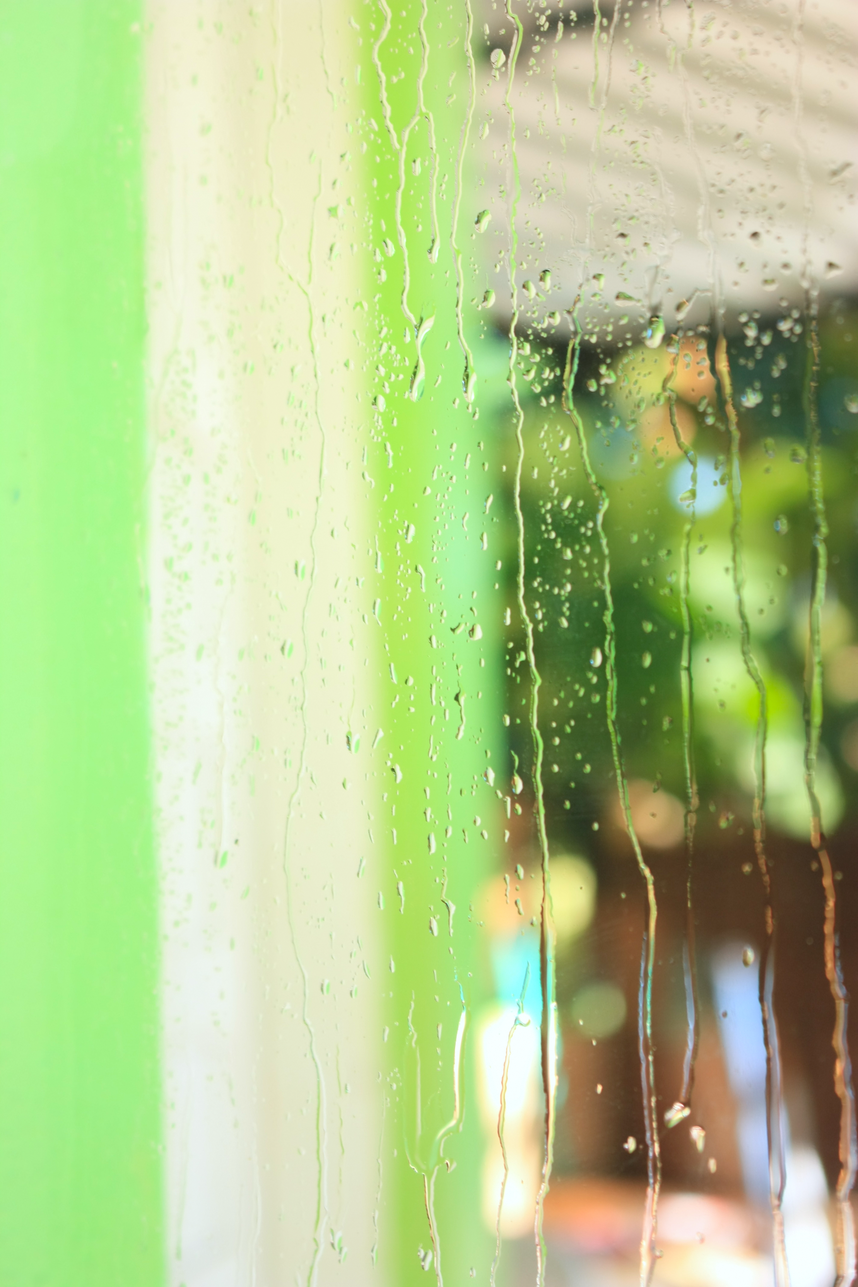 Raindrops streak down a wet window pane. photo – Free Abstract Image on ...