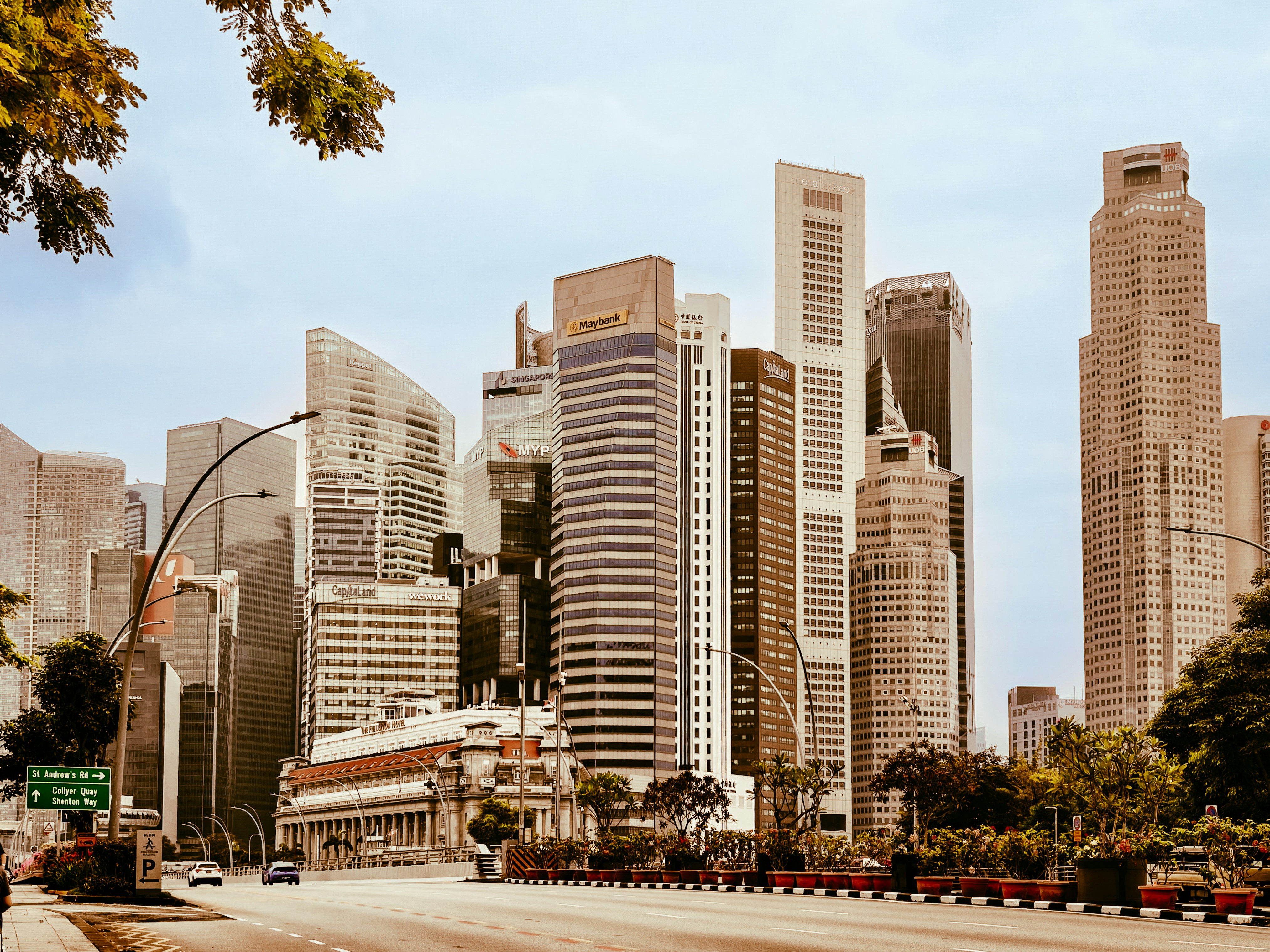 Cluster of modern skyscrapers in Singapore under a clear sky.