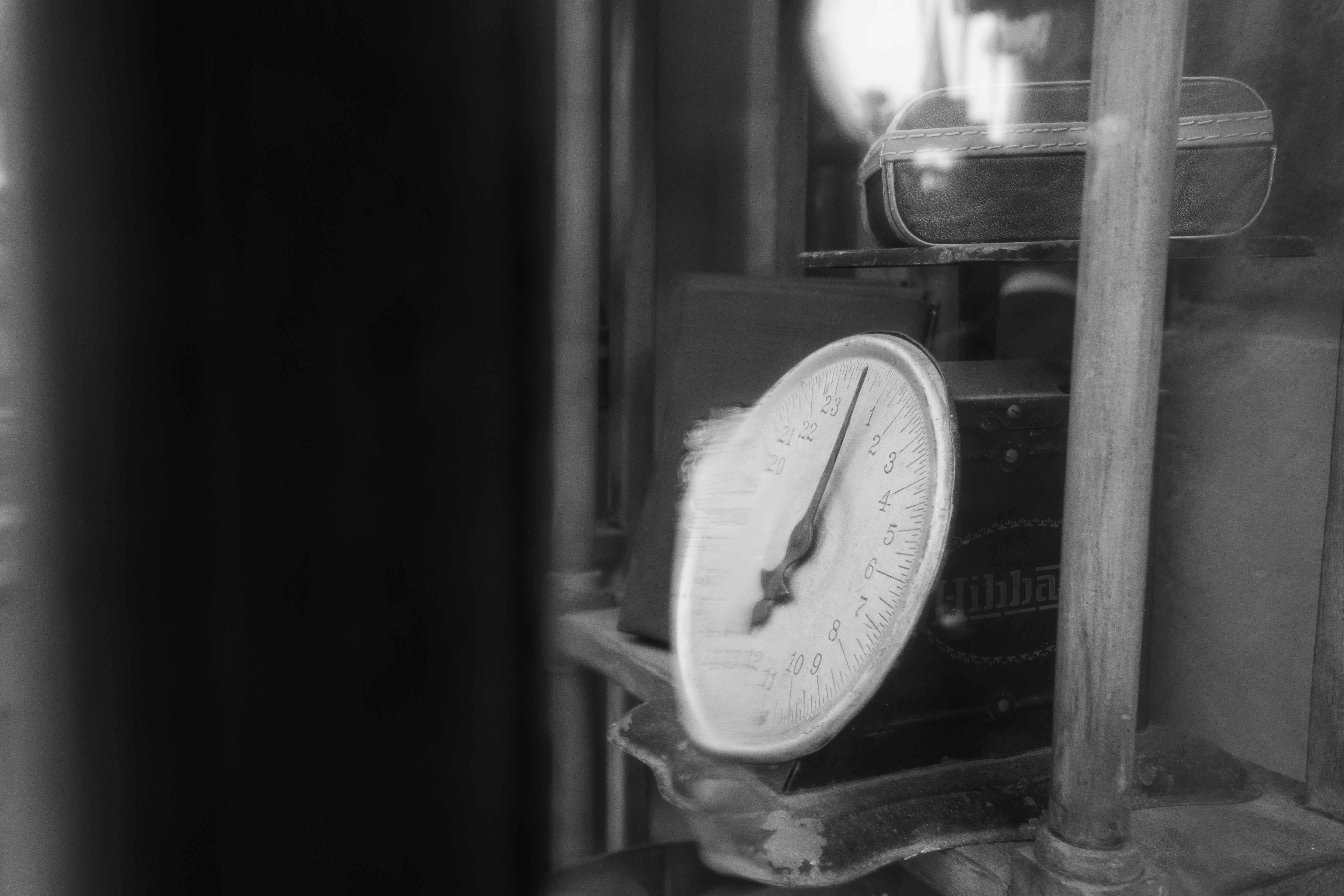 A close-up of a vintage scale, showcasing its intricate details and weathered charm. The monochrome setting emphasizes its timeless appeal.