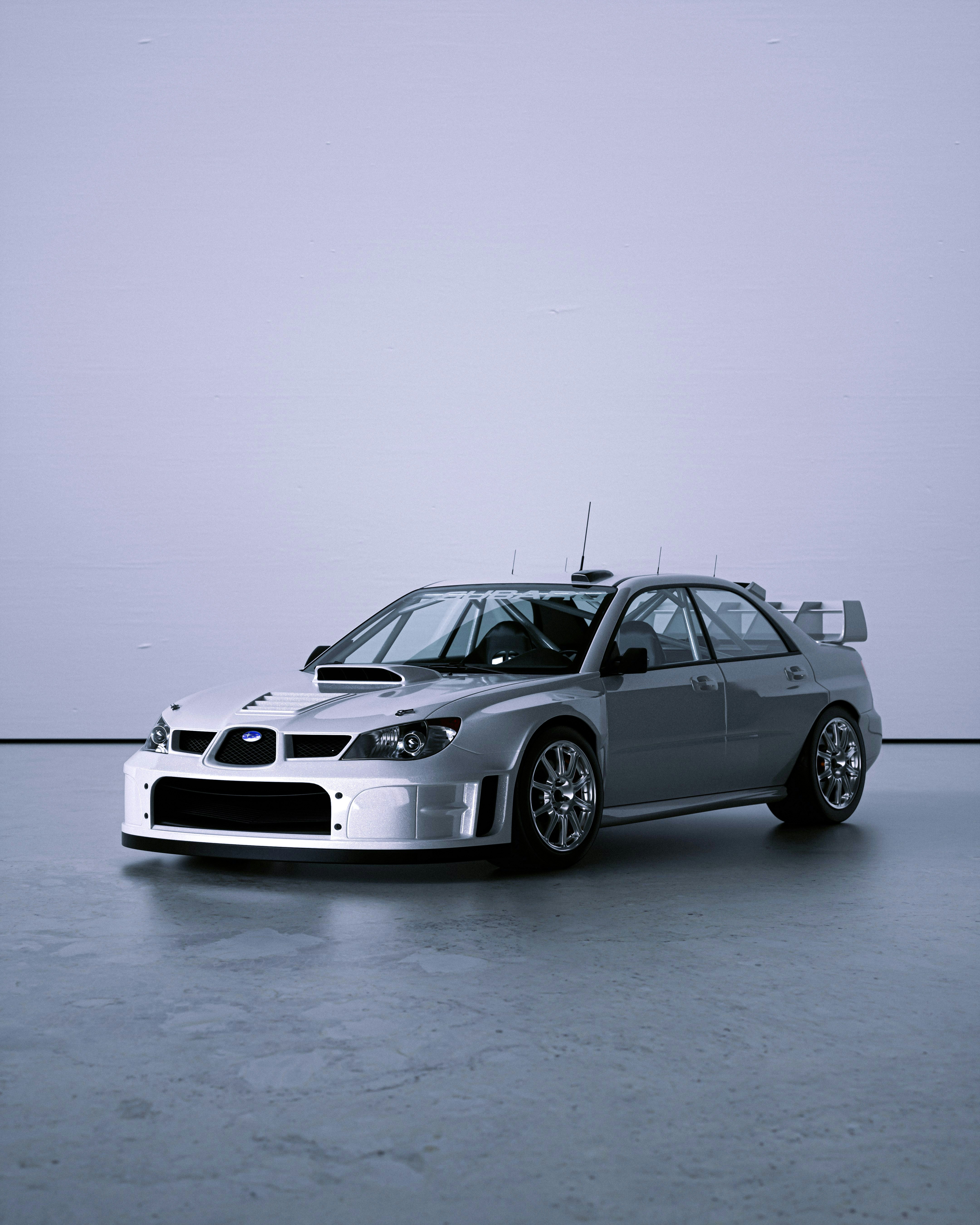 A silver subaru rally car sits inside a studio. photo – Free Digital ...
