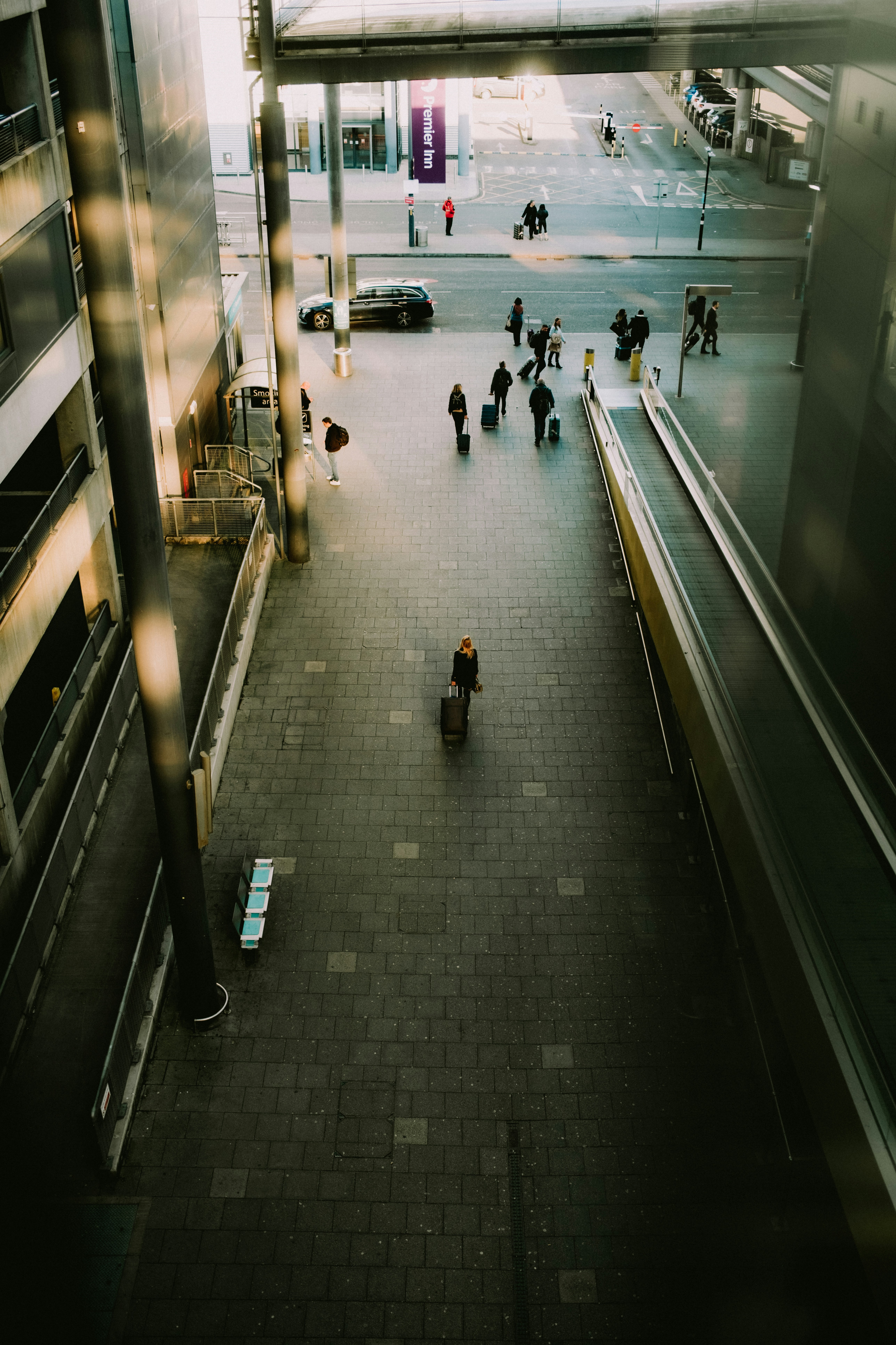 People are seen walking through a modern walkway. photo – Free Travel ...