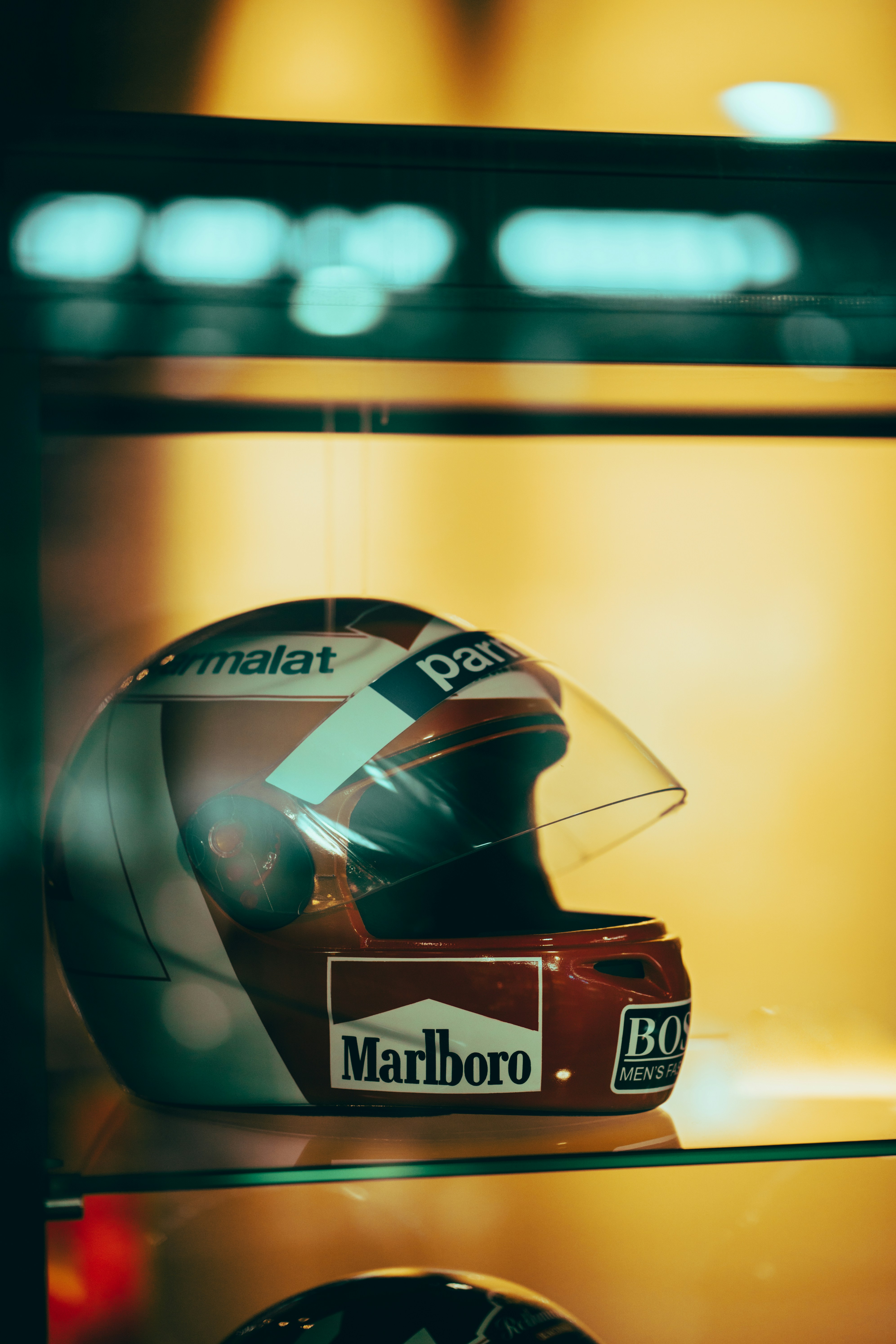 A vintage formula 1 helmet in a display case. photo – Free Germany ...