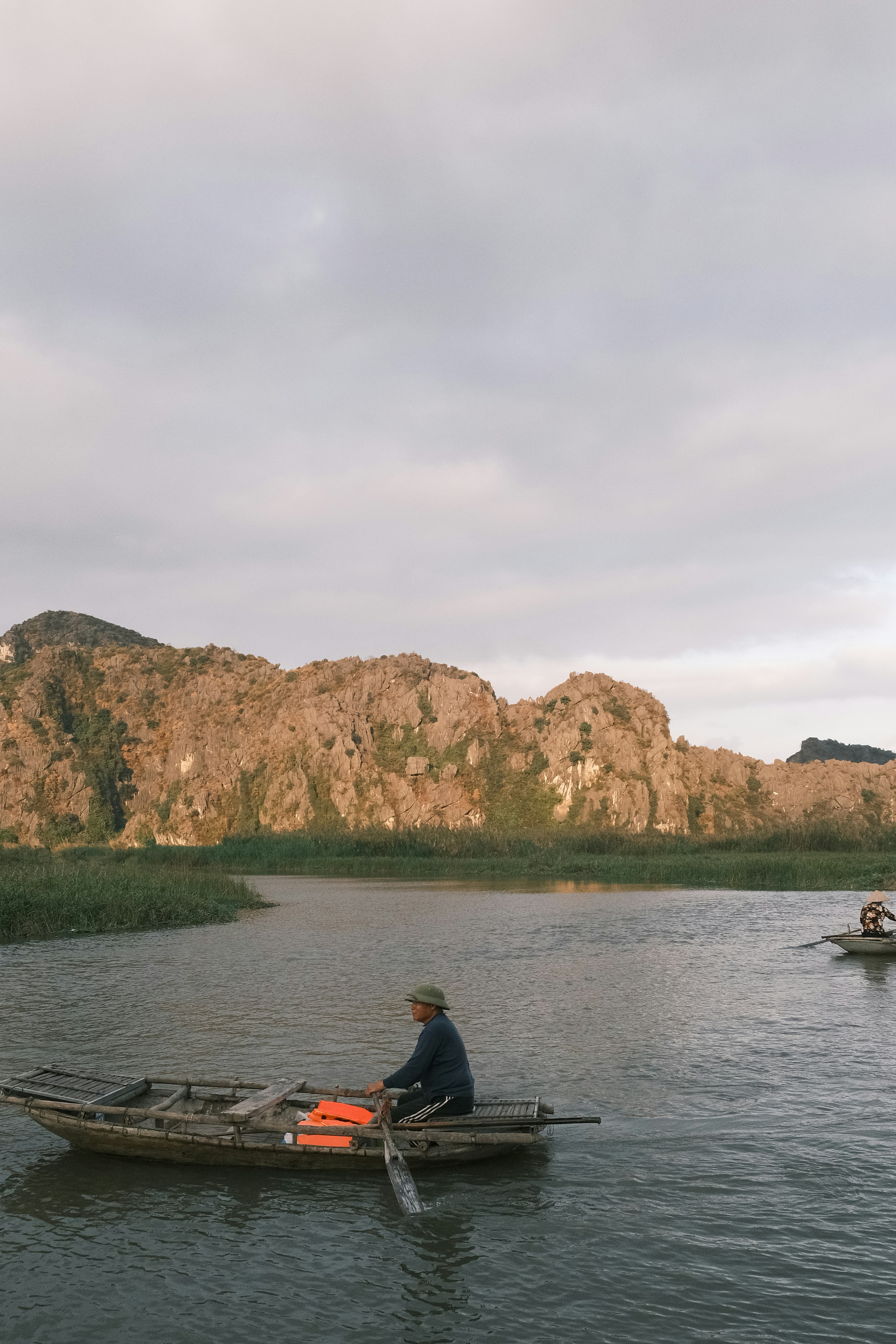 Lone Boater on a Quiet River Beneath Granite Cliffs