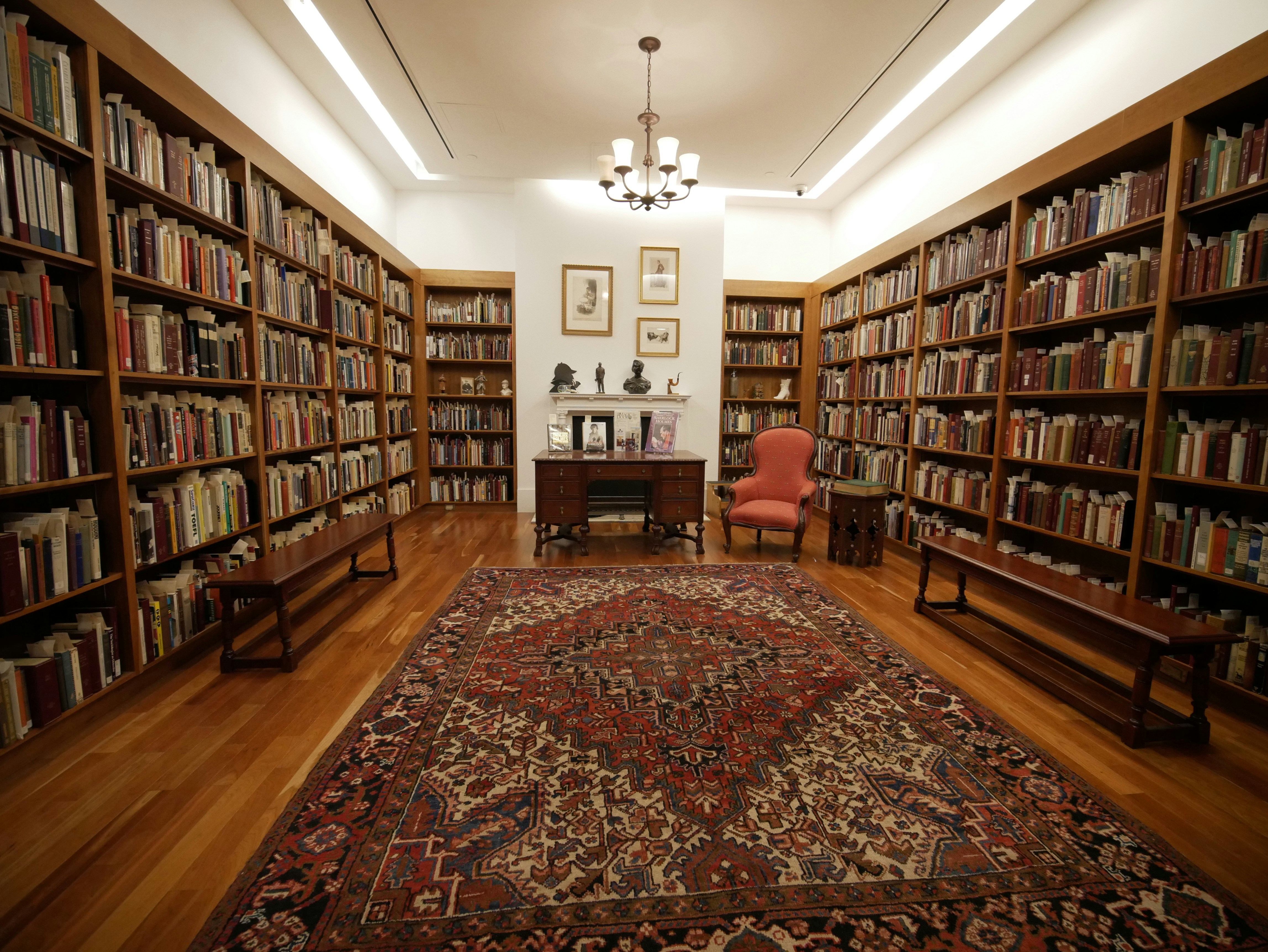 A library filled with books, a desk, and rug. photo – Free Art Image on ...