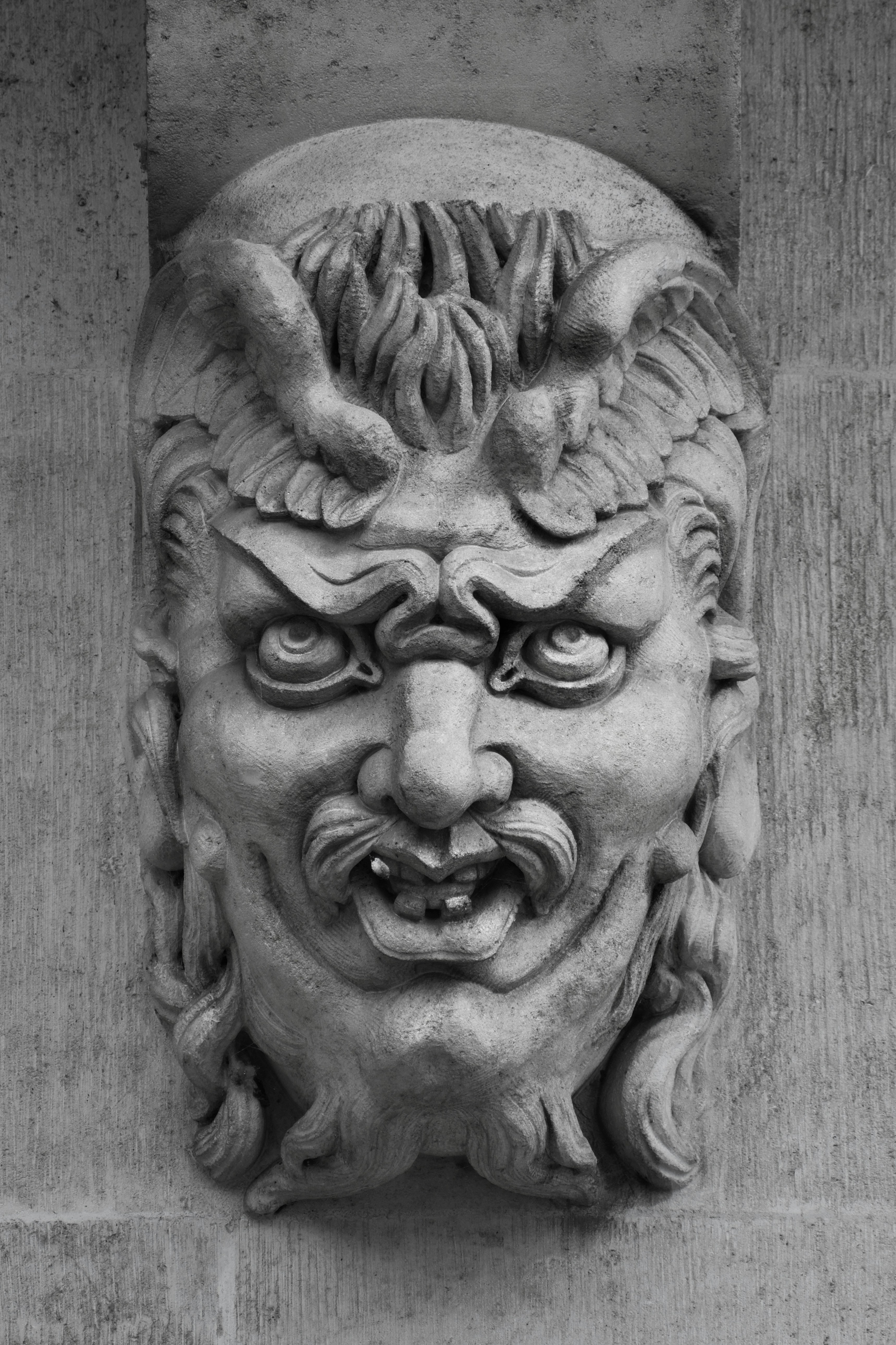 Stone carving of a grotesque, angry face. photo – Free Paris Image on ...