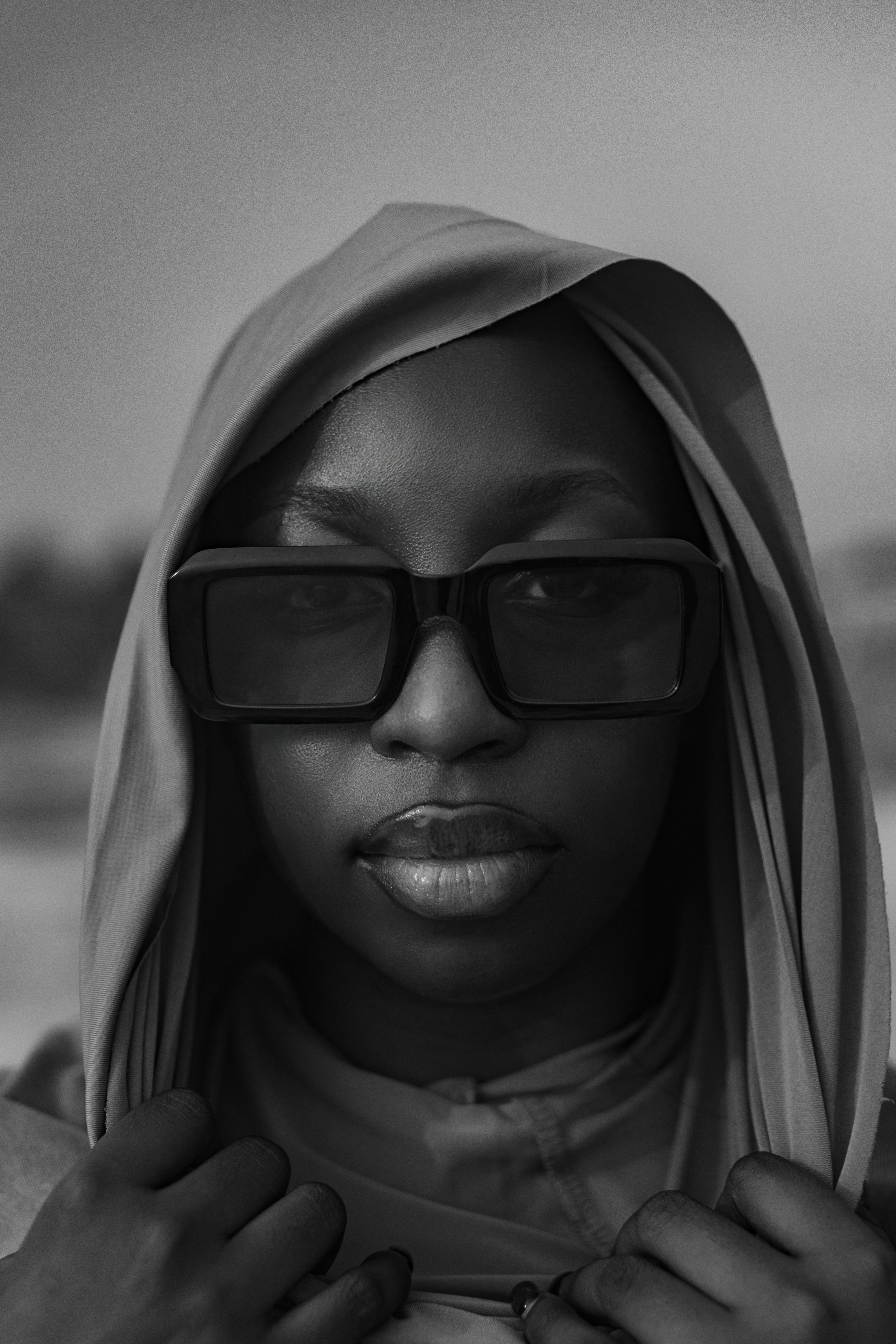 A woman poses in a hood and sunglasses. photo – Free Portrait Image on ...