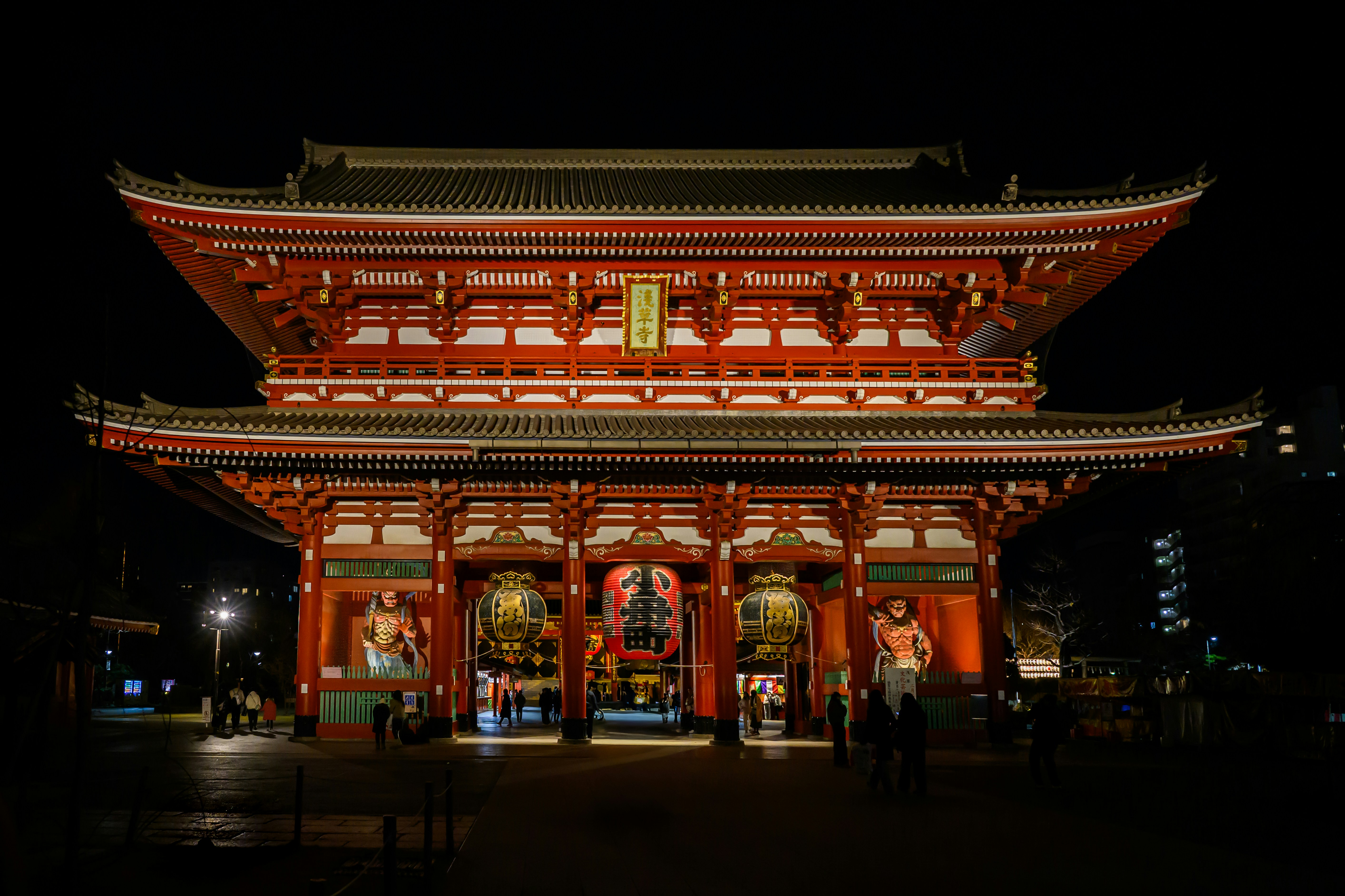 Hōzōmon Gate at Senso-ji Temple in Tokyo, brilliantly lit against the night sky.