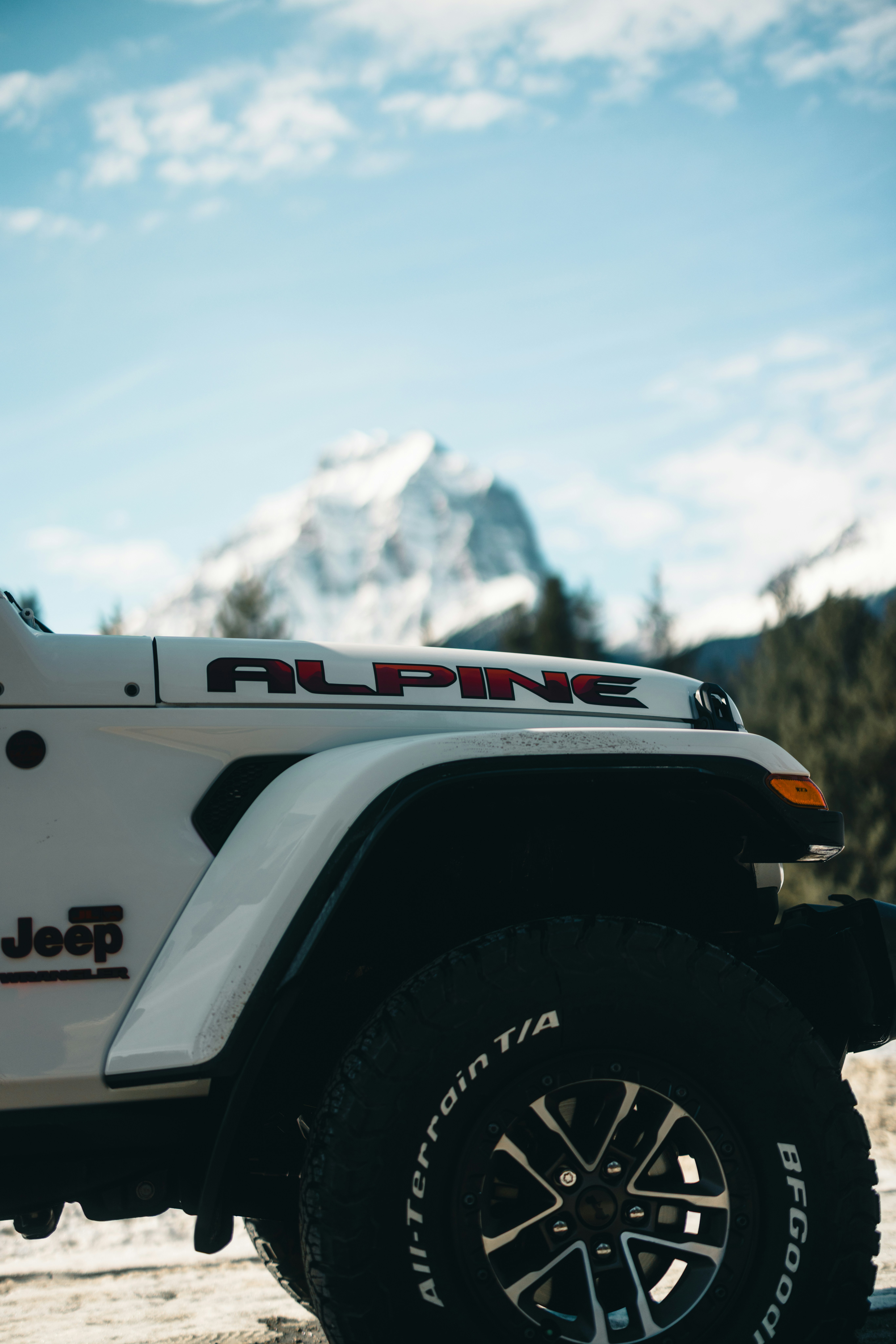 A jeep "alpine" sits before a snowy mountain. photo – Free Car Image on ...