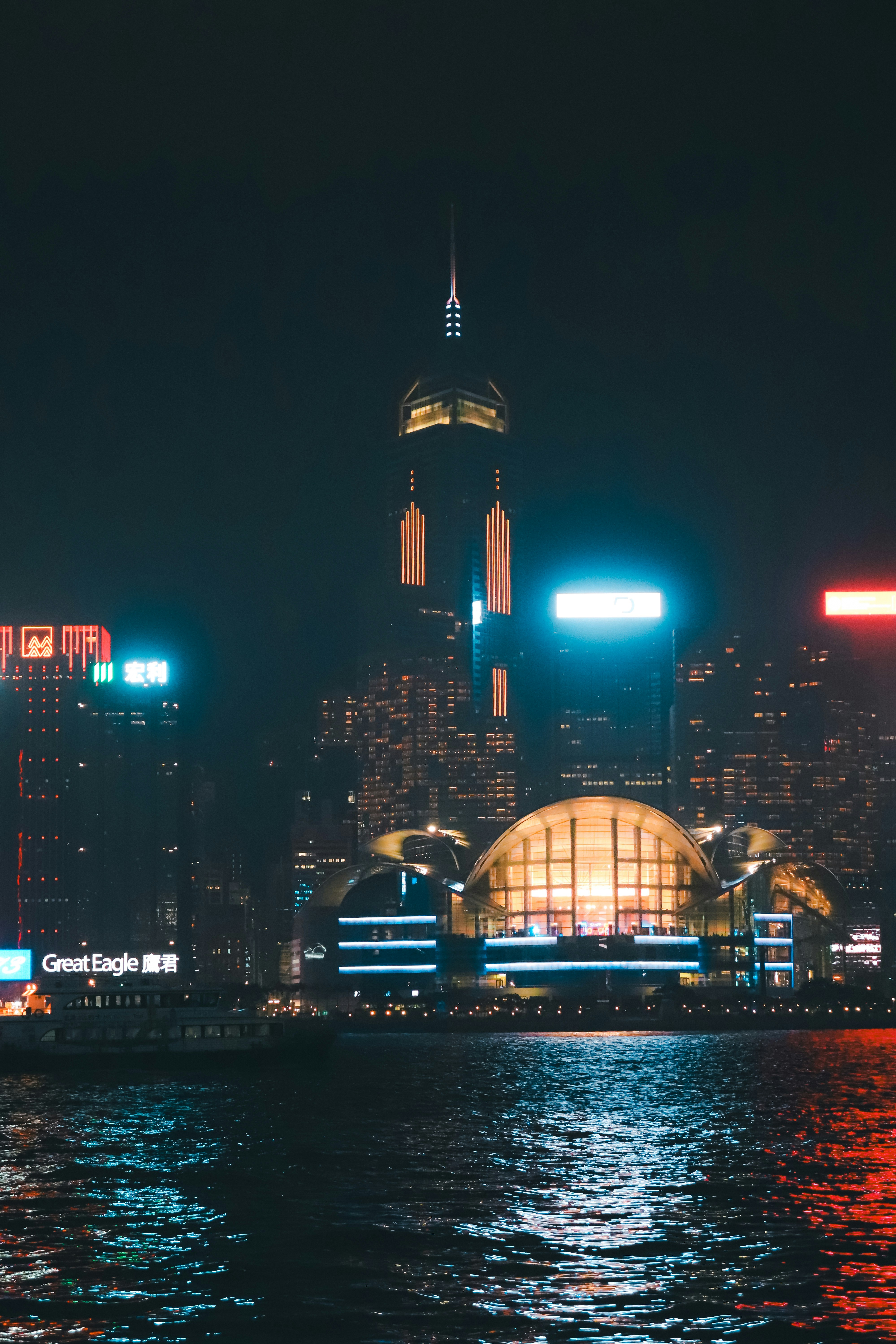 Hong kong skyline illuminated at night over the water. photo – Free ...