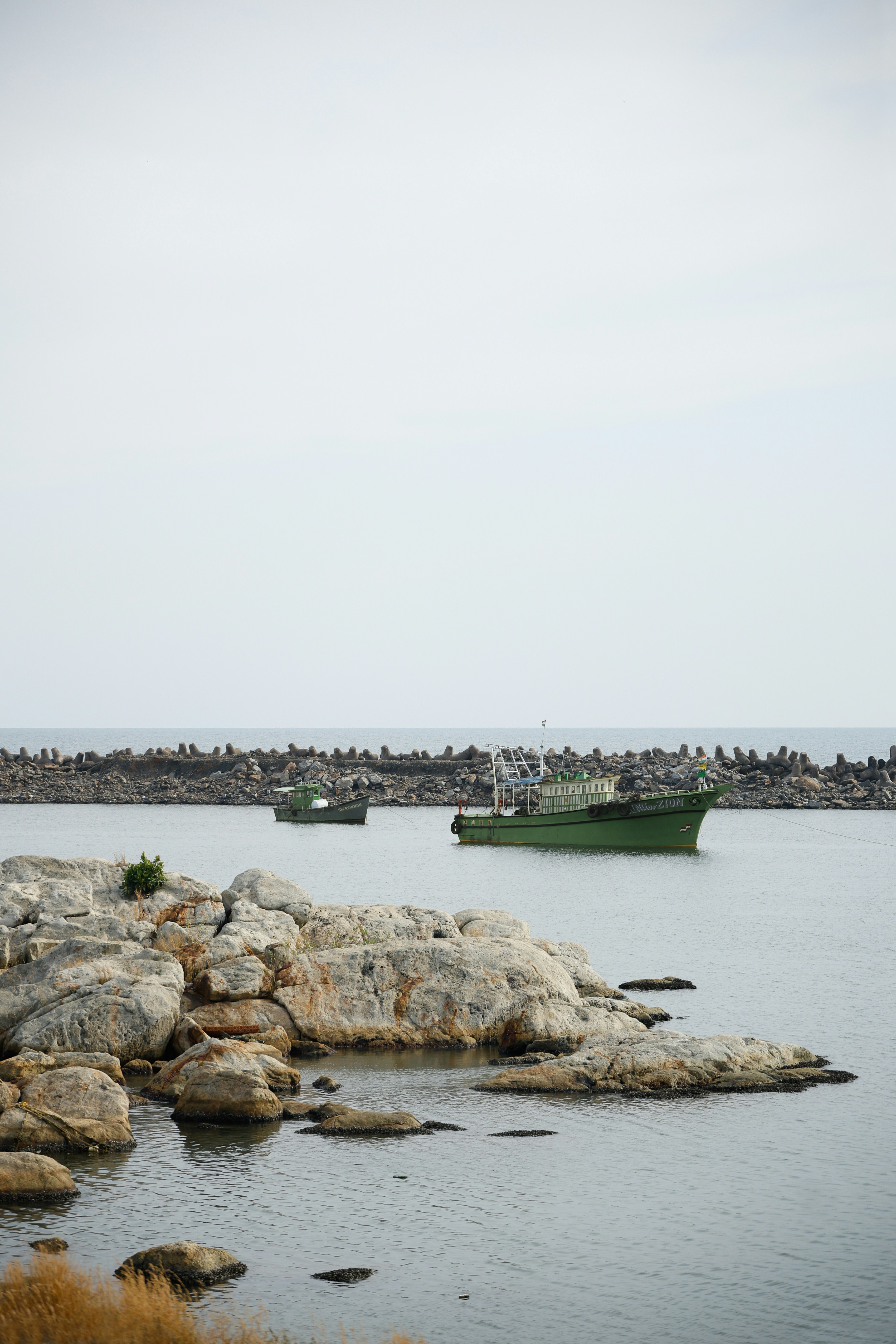 Emerald Vessel at the Quiet Breakwater