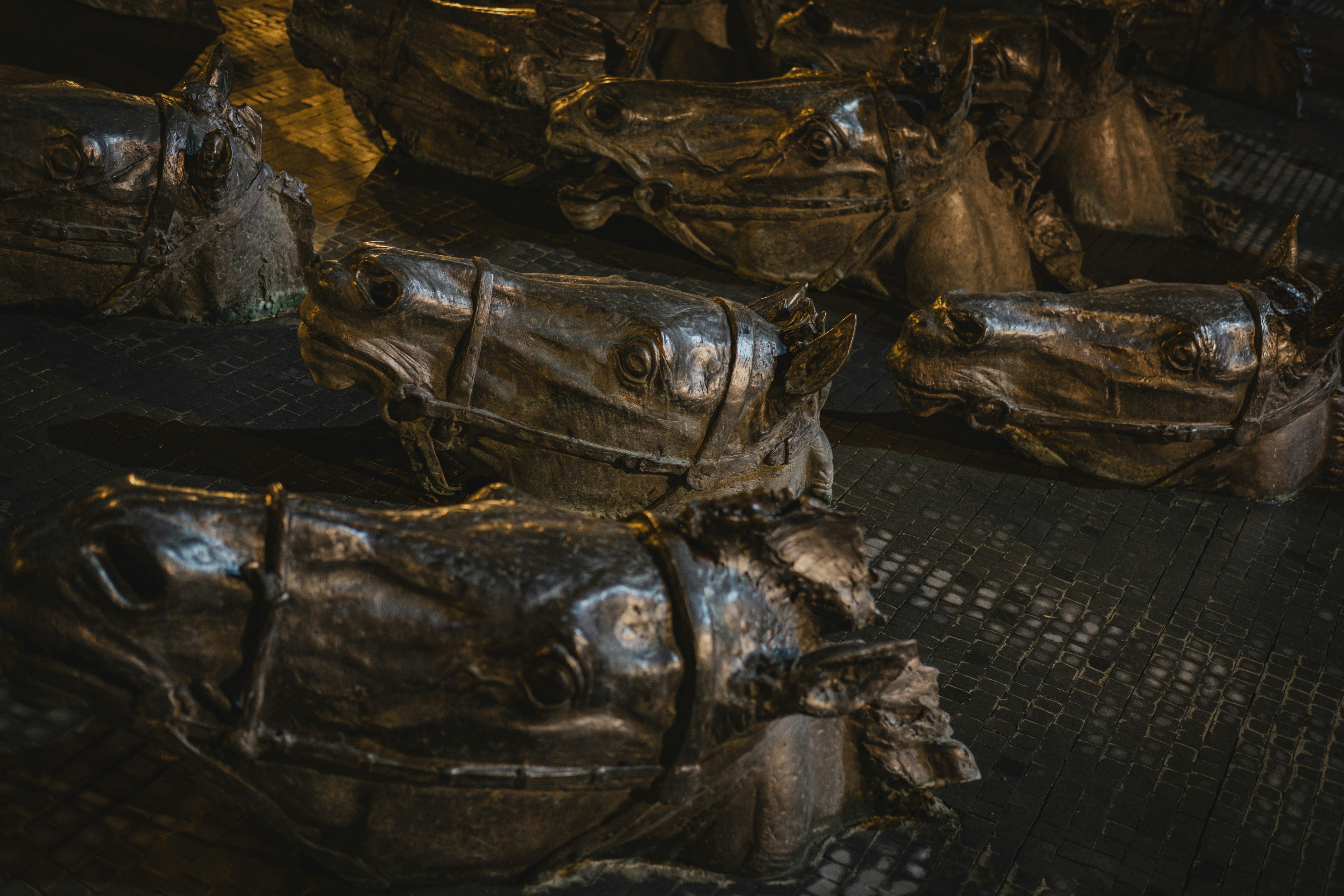 Charred Footwear Lined Across a Textured Metal Grate