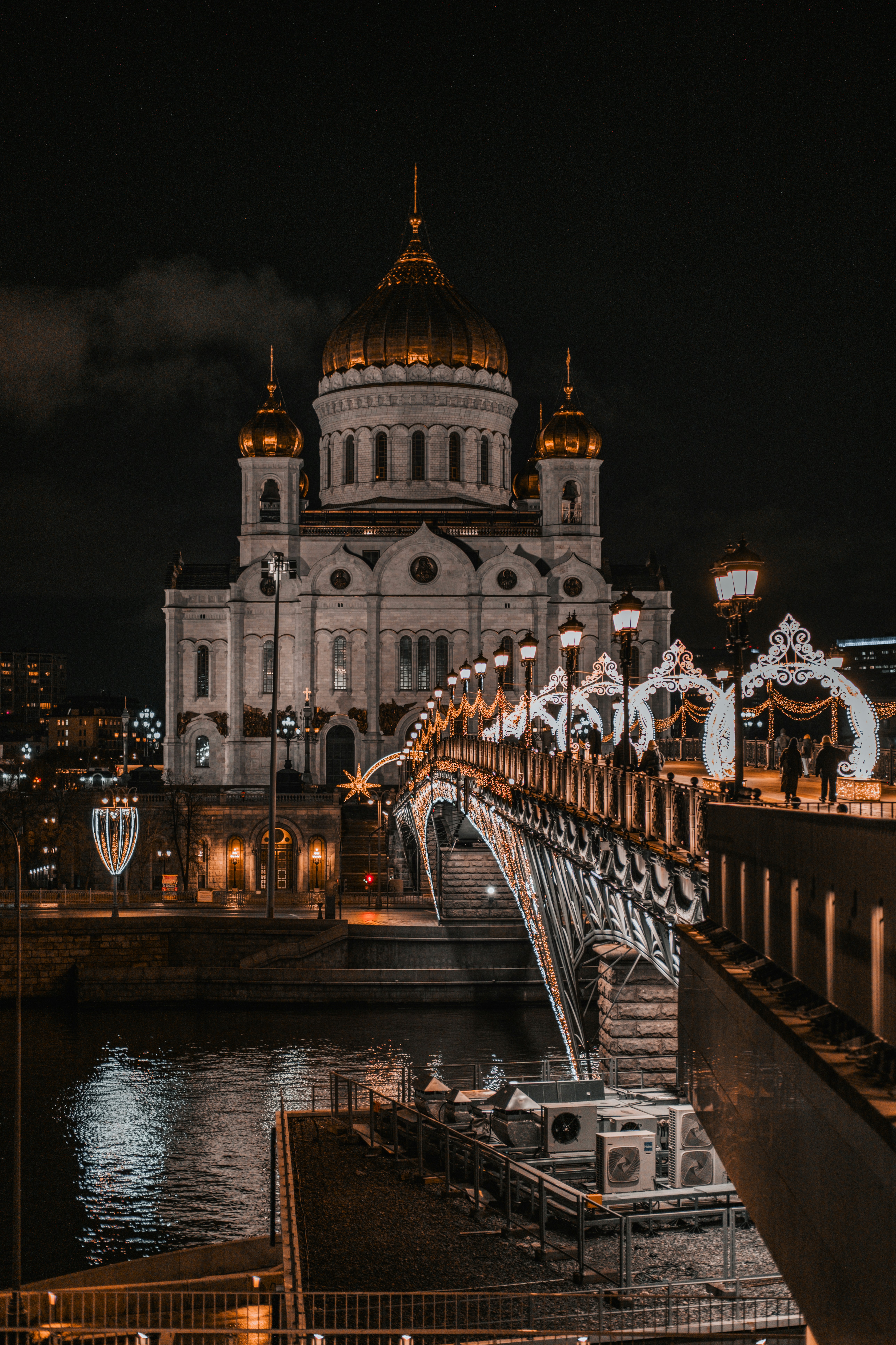 Nighttime Cathedral and Illuminated Bridge: A Cityscape of Warm Lights