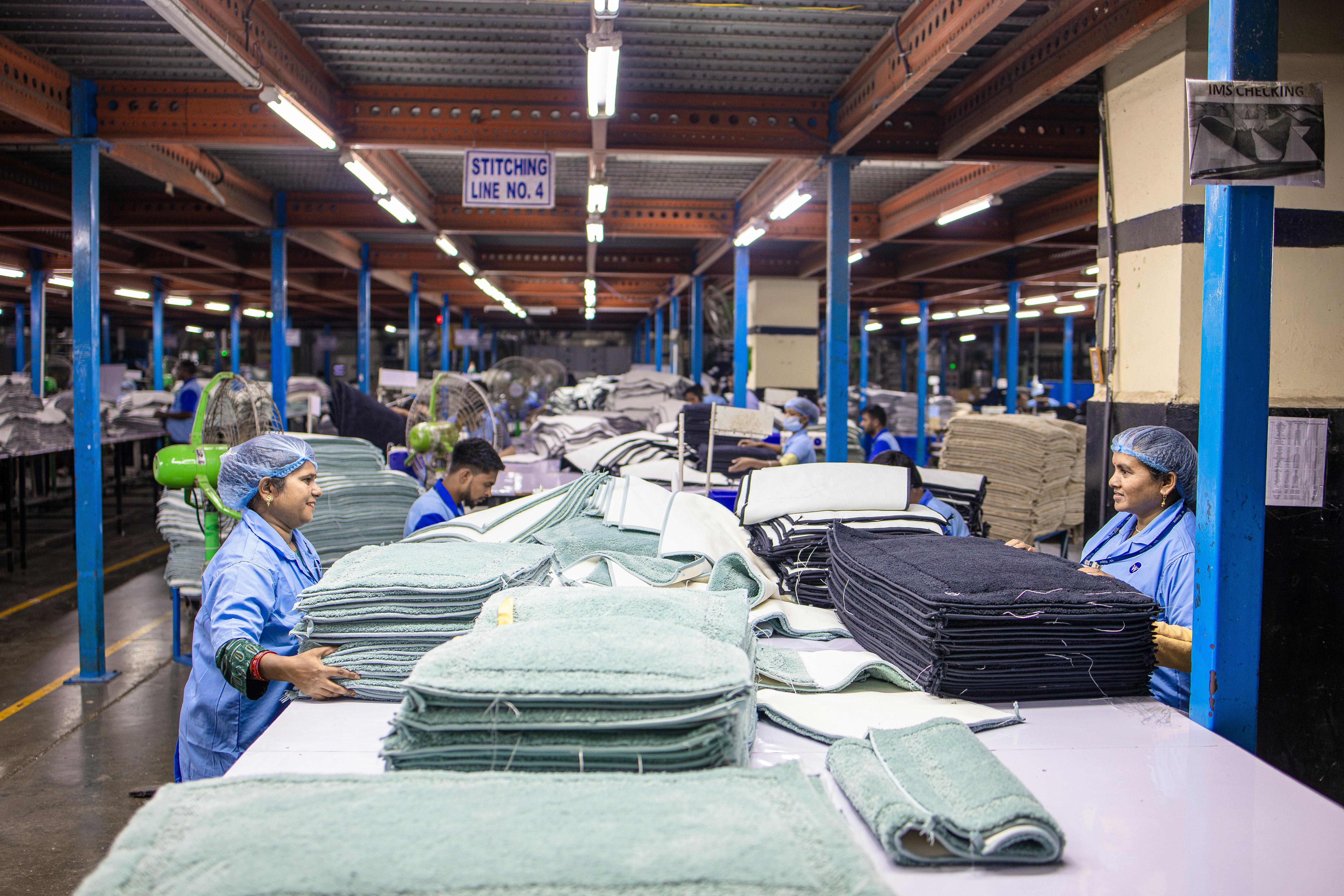 Textile workers are sorting fabric in a factory. photo – Free Worker ...