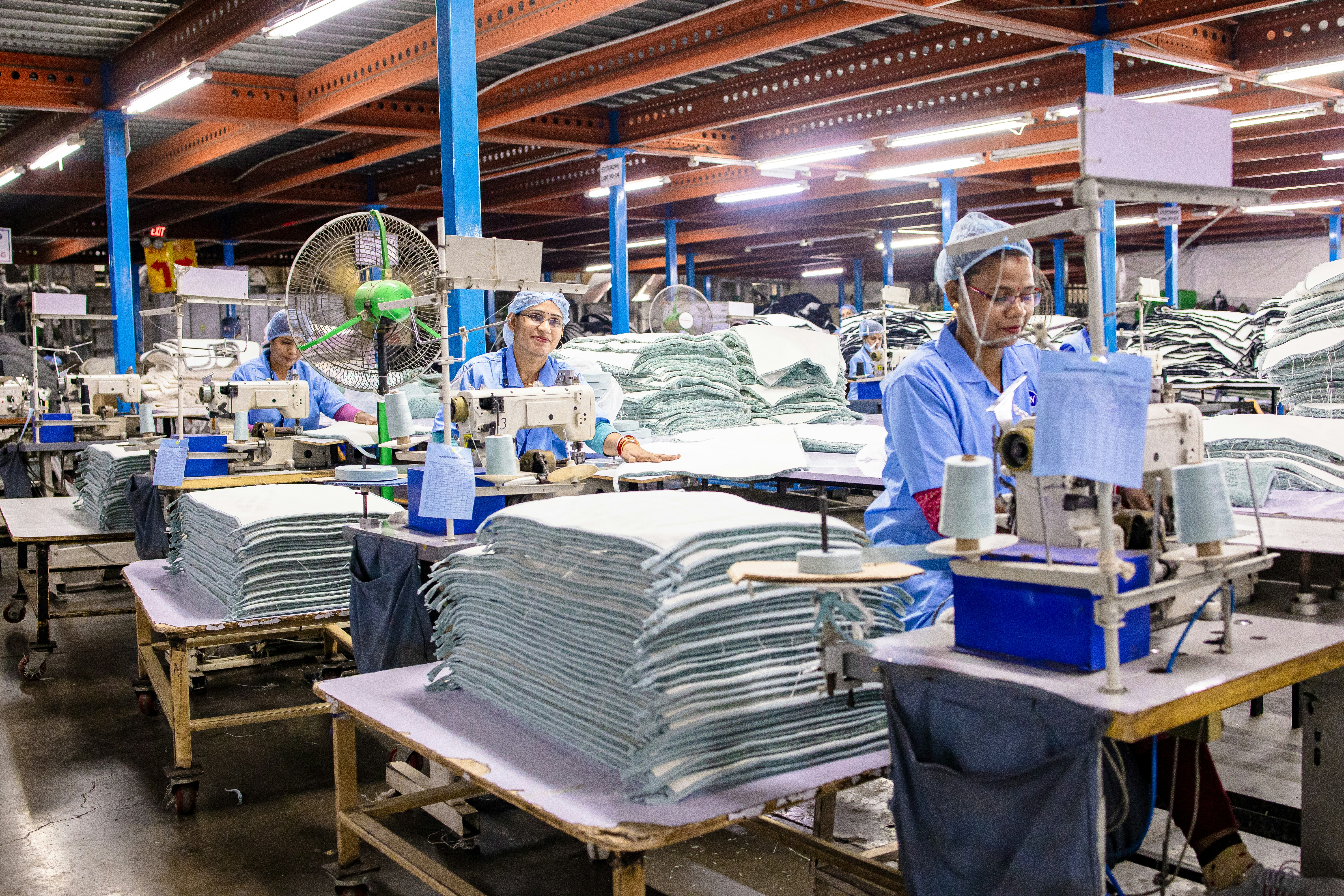 Workers are sewing textiles in an industrial factory. photo – Free ...