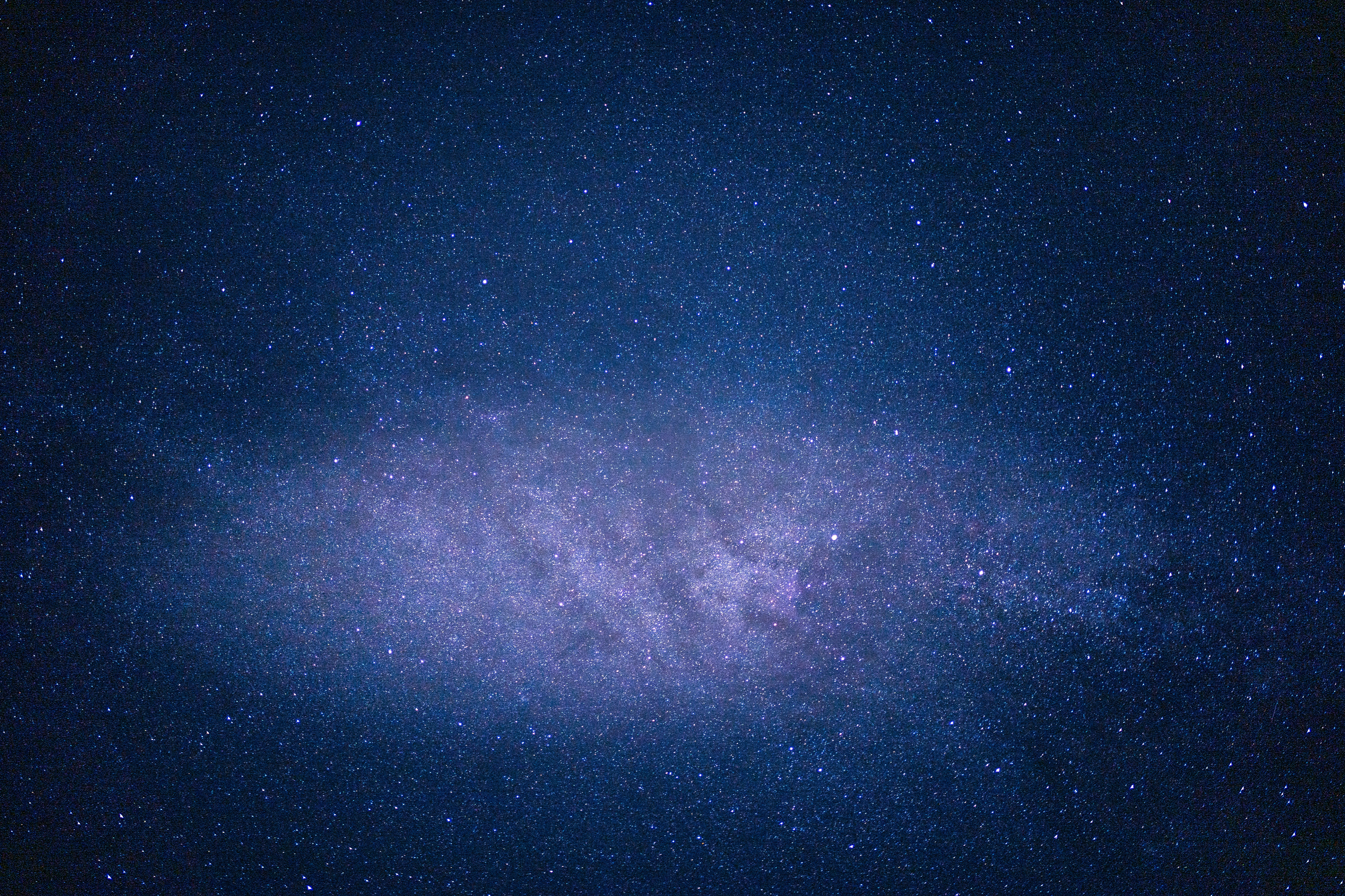 Expansive night sky filled with countless stars forming a dense cosmic cloud.