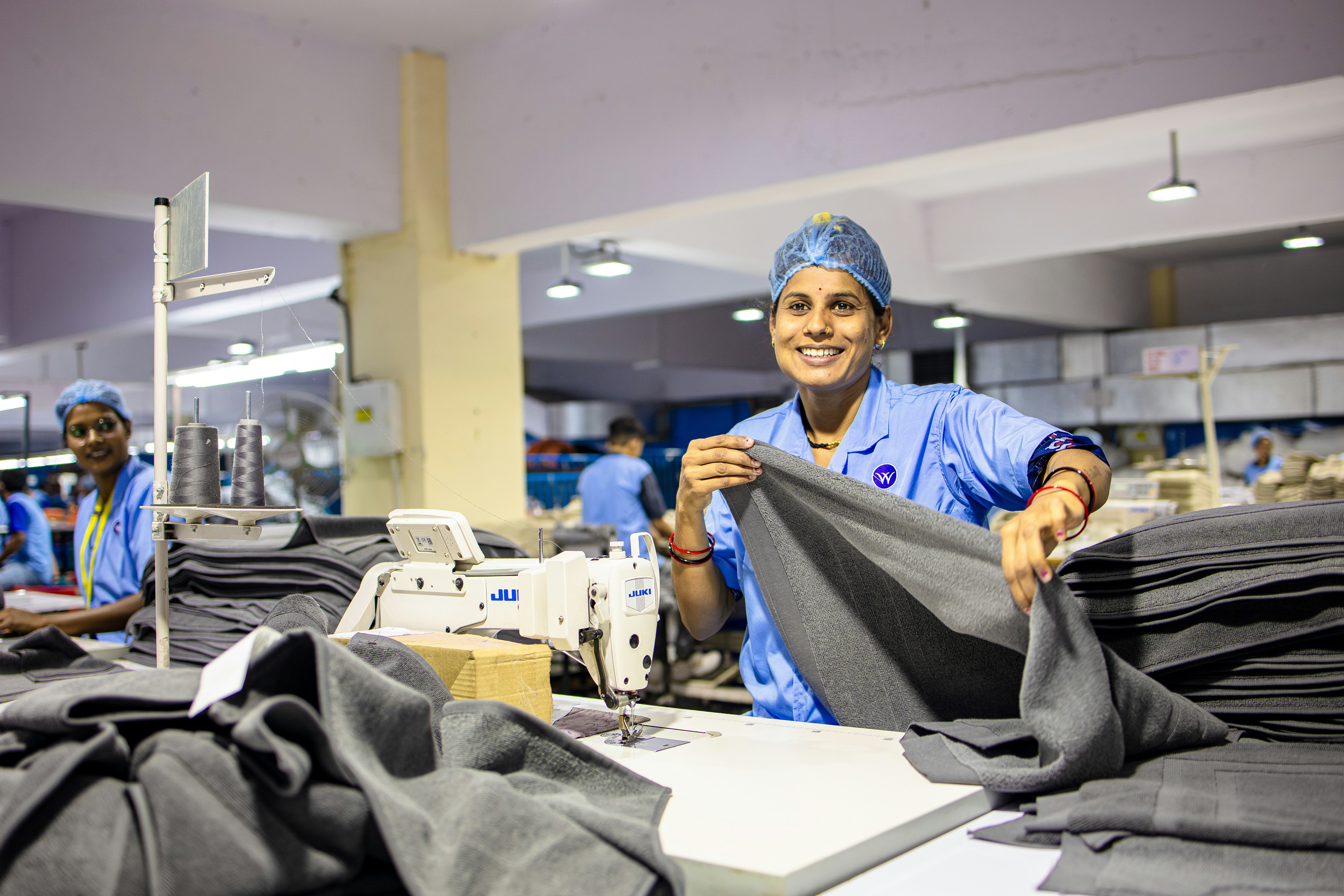 Workers are smiling at a clothing manufacturing facility. photo – Free ...