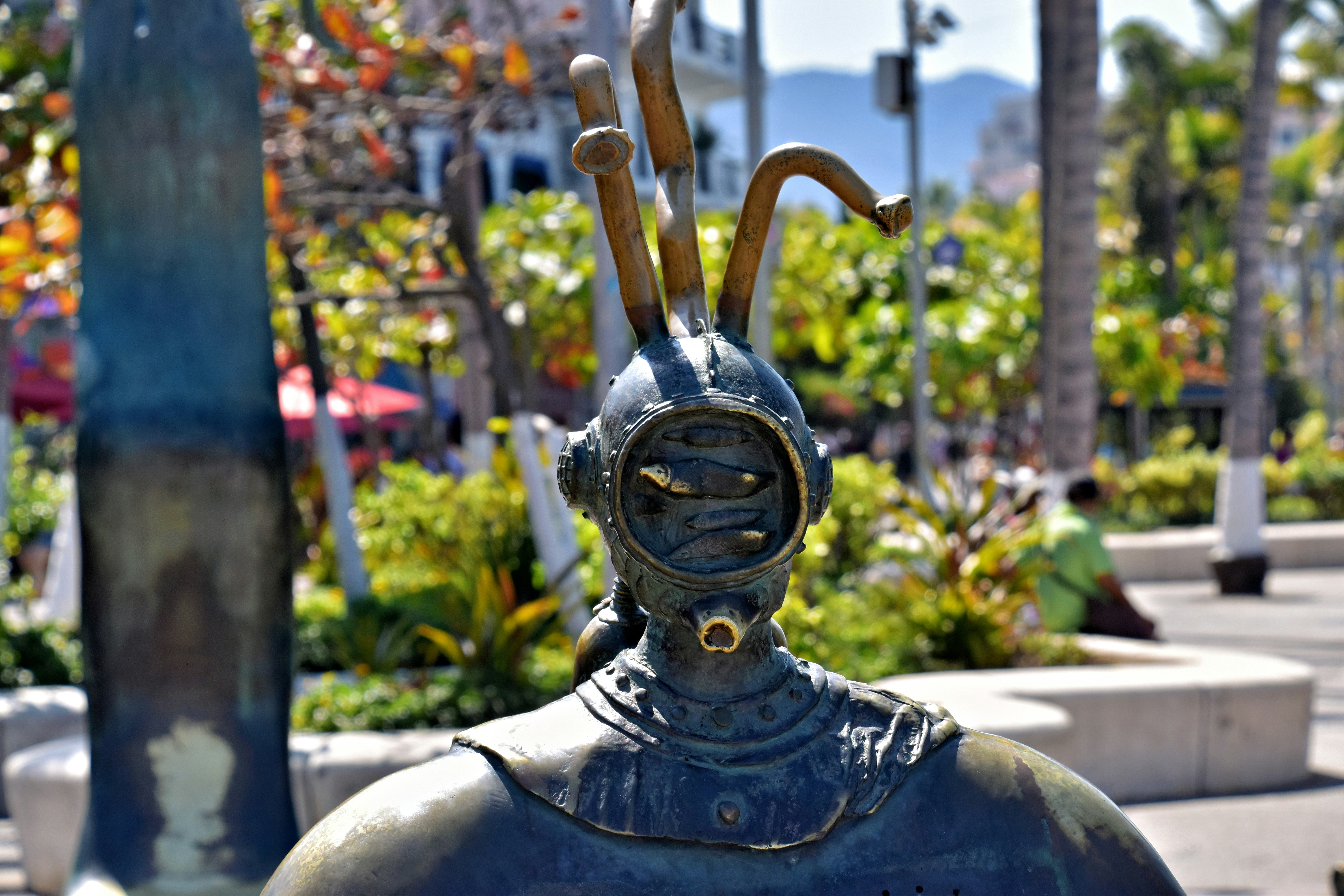 Helmeted Sailor Statue Under Sunlit Plaza