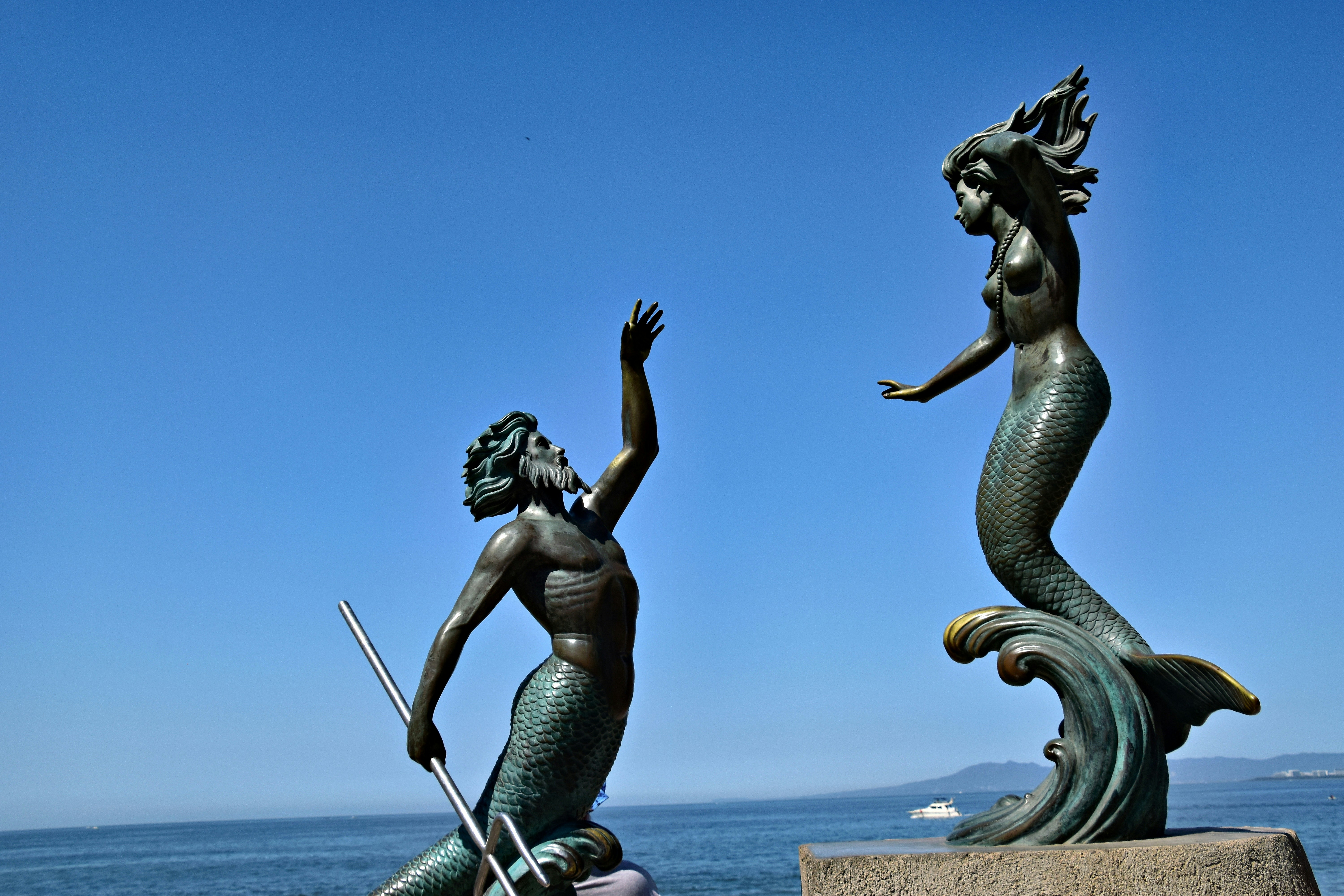 A mermaid statue interacts with a male water god. photo – Free Woman ...