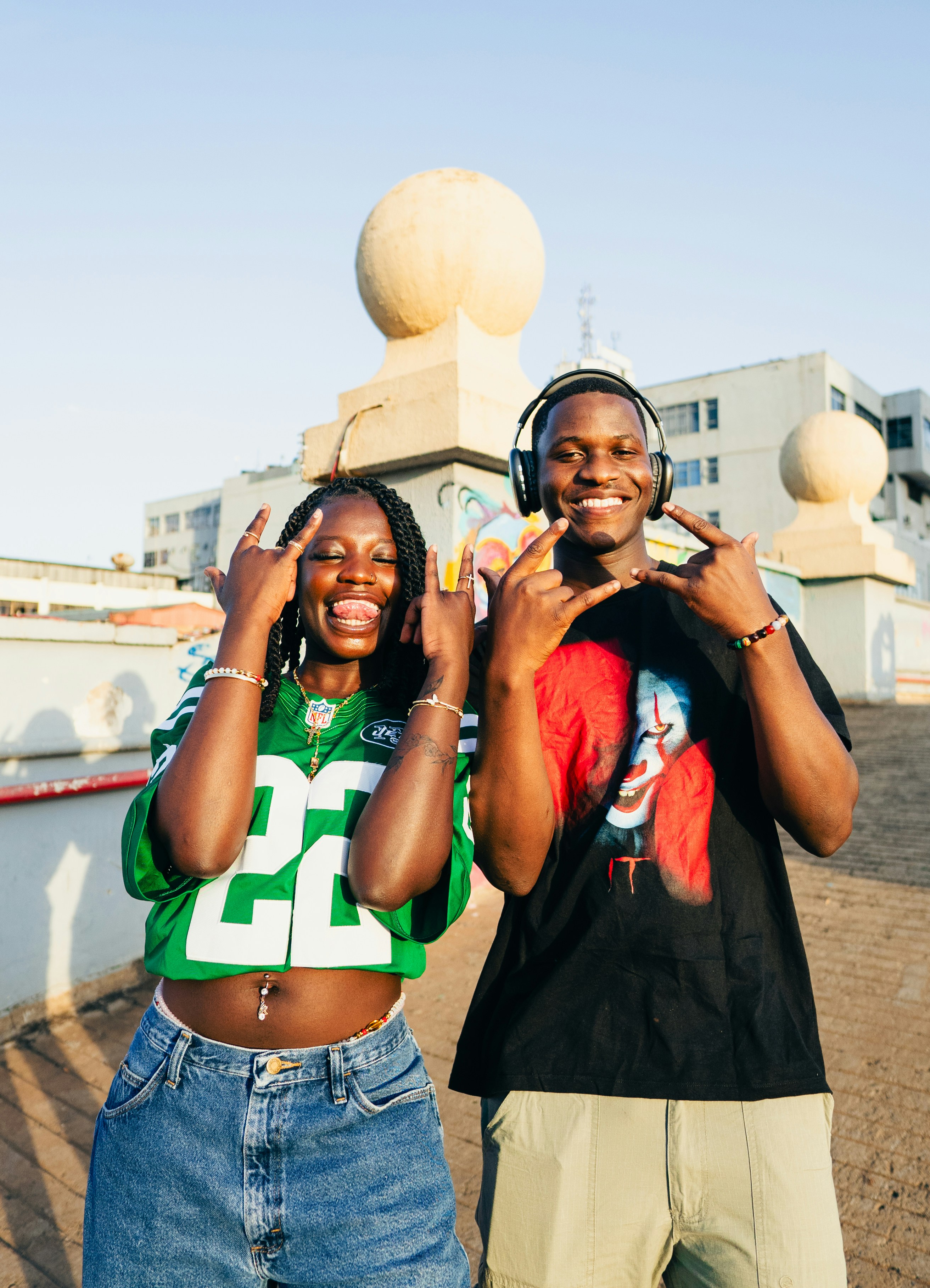 Two friends are having fun and making rock-on signs. photo – Free ...