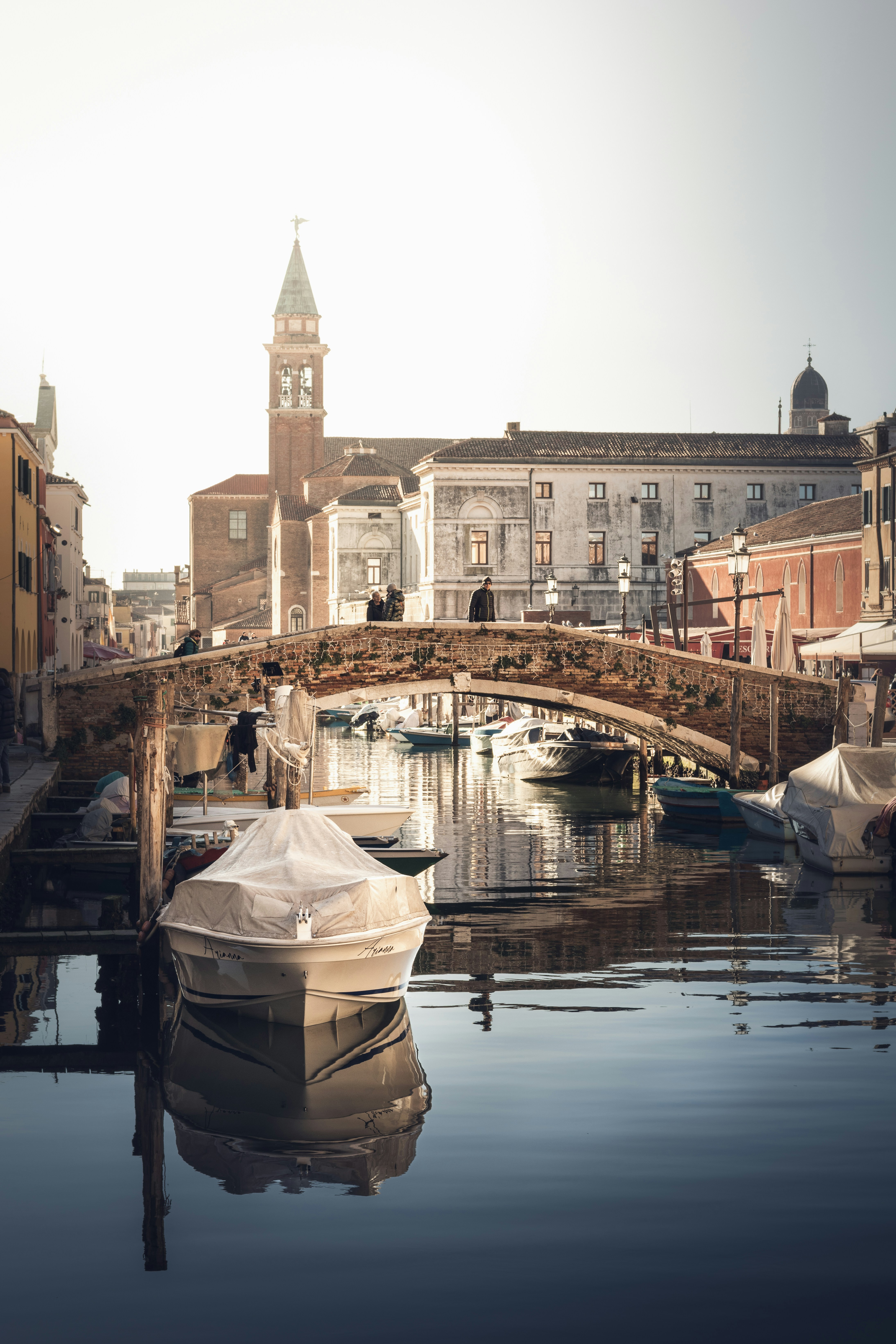 Sunlit Arch Over a Quiet Italian Canal