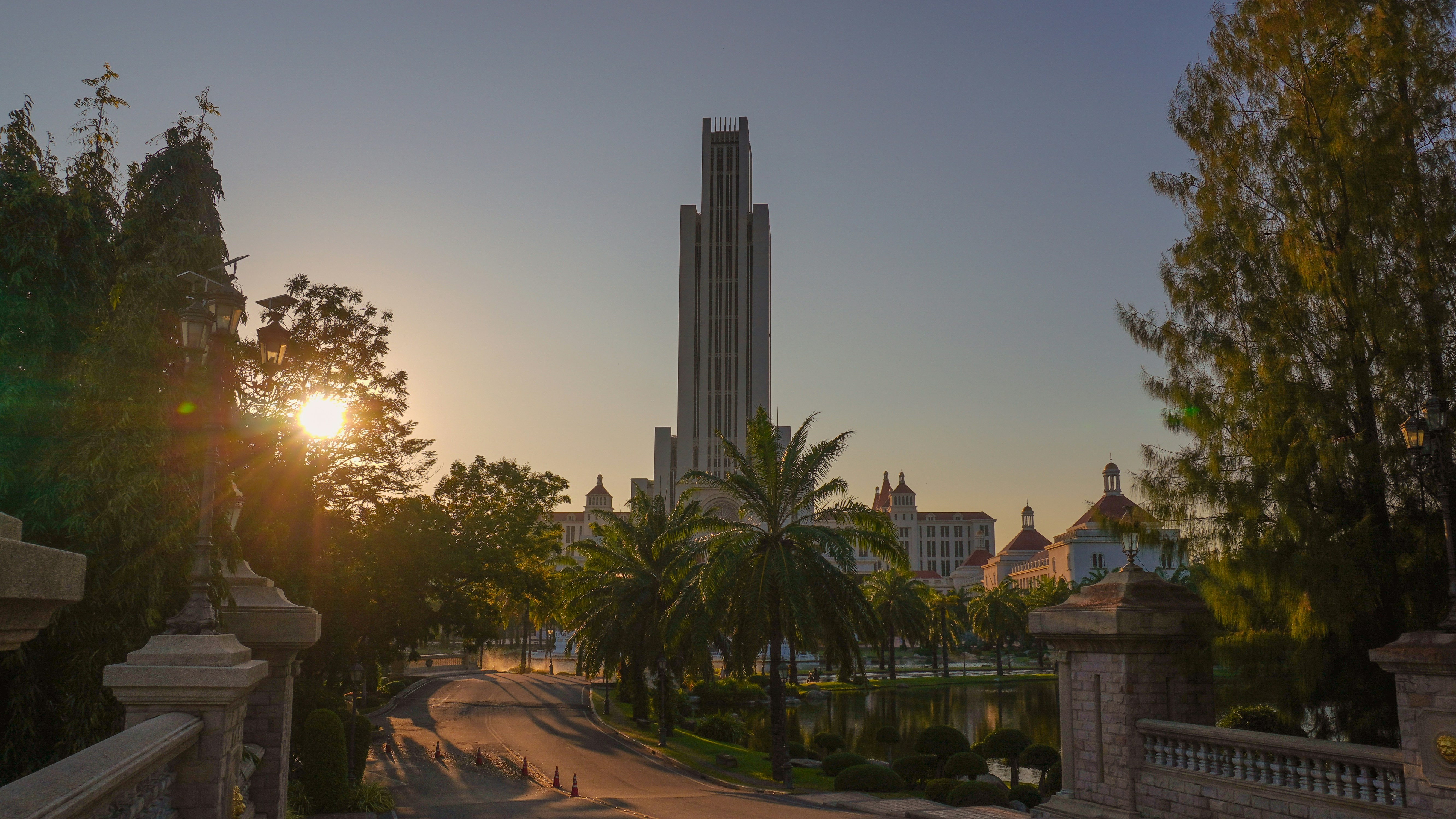 Tall, modern building rises majestically into the sunrise.