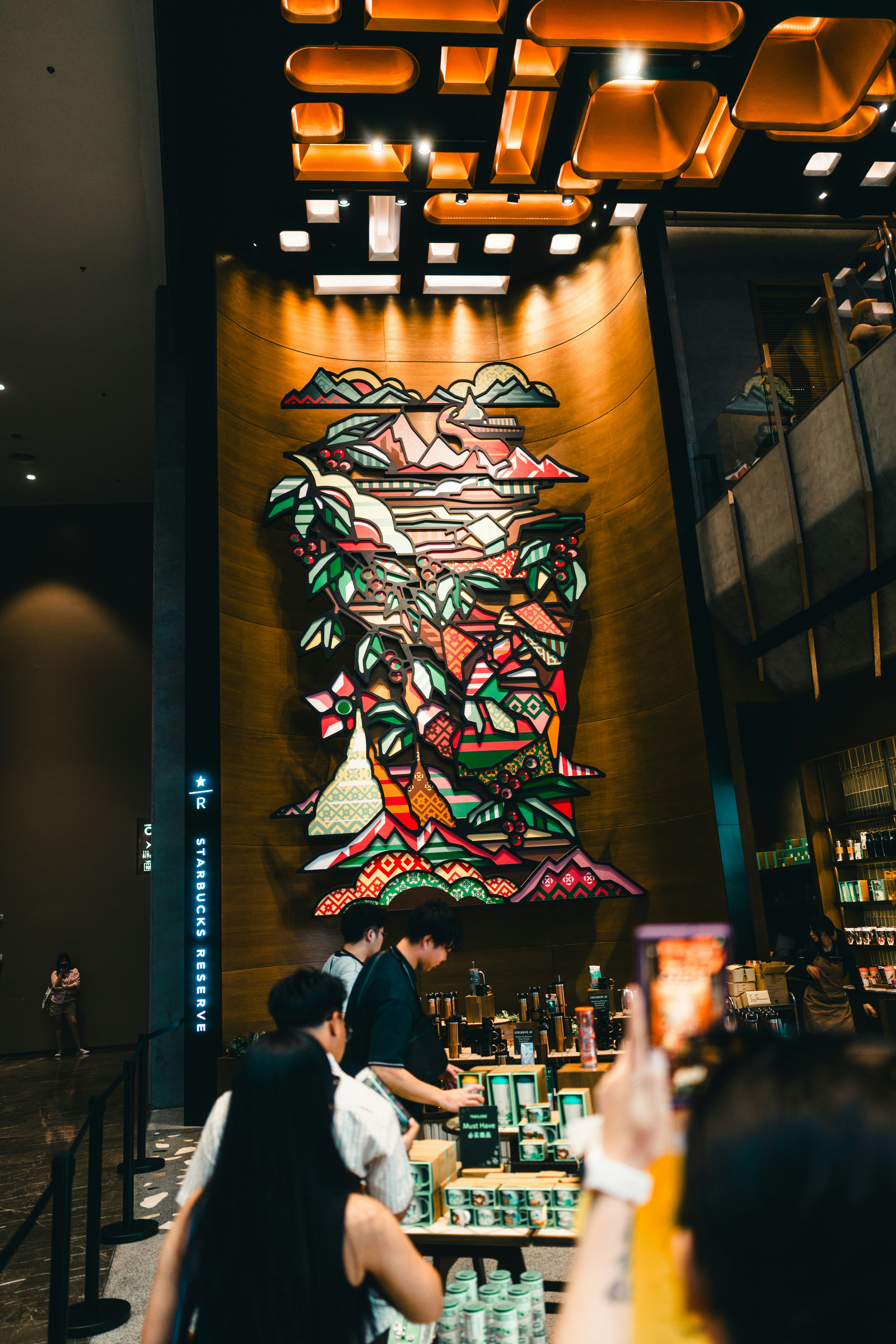 Vibrant Mountaintop Mosaic Dominates a Busy Café Interior