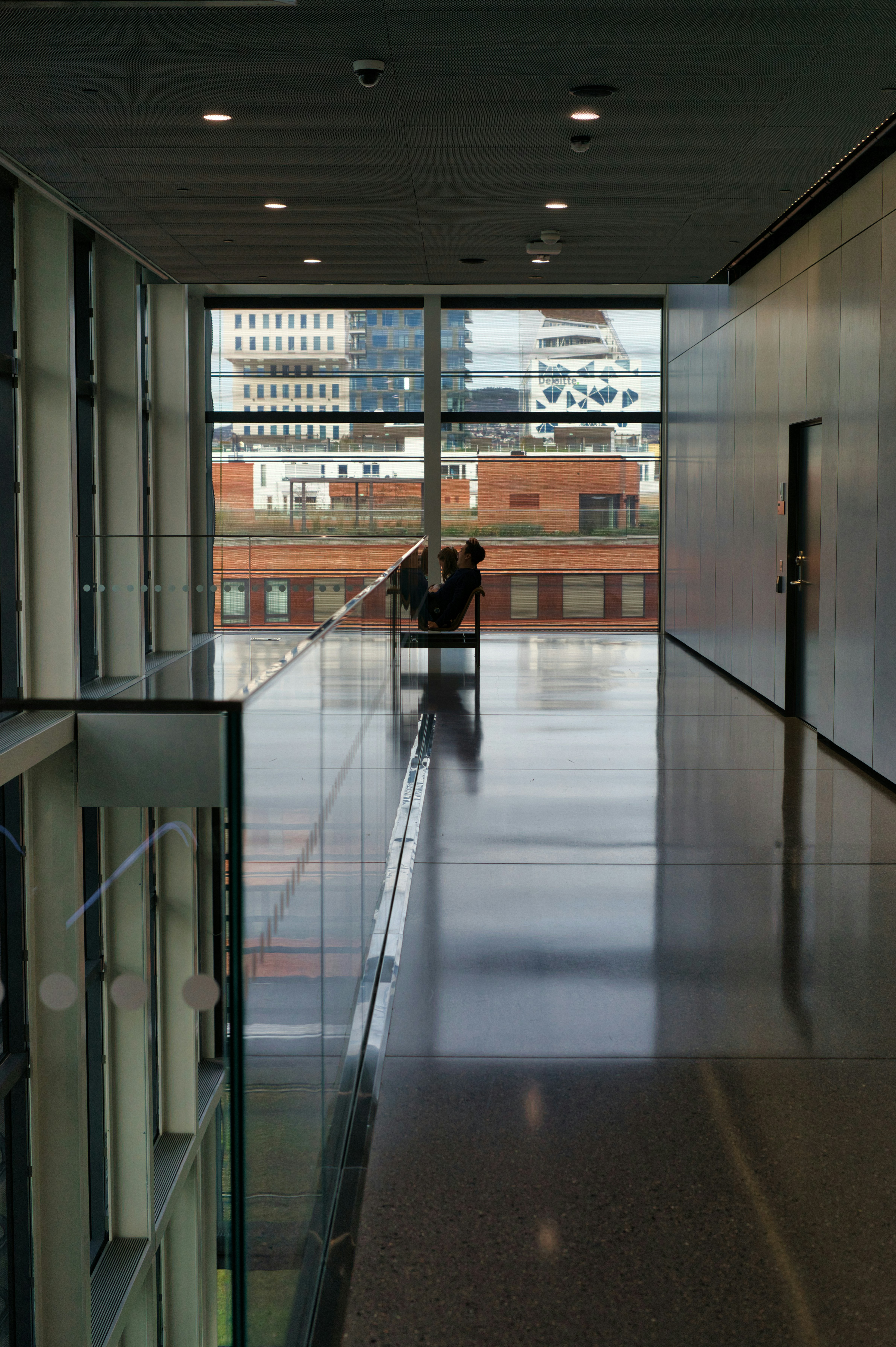 A long hallway with an urban view outside. photo – Free Building Image ...