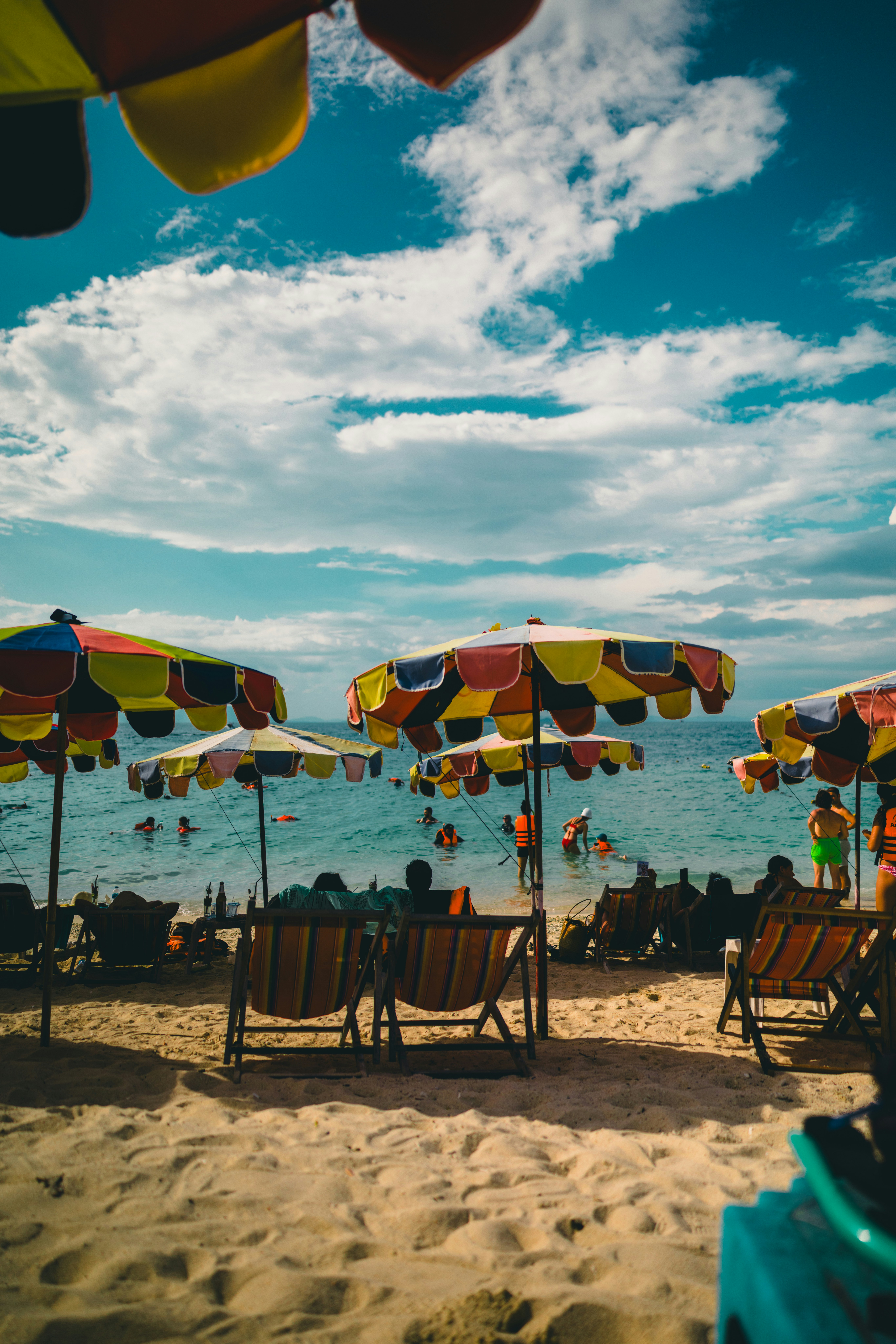 Beach scene with colorful umbrellas and people. photo – Free Forest ...