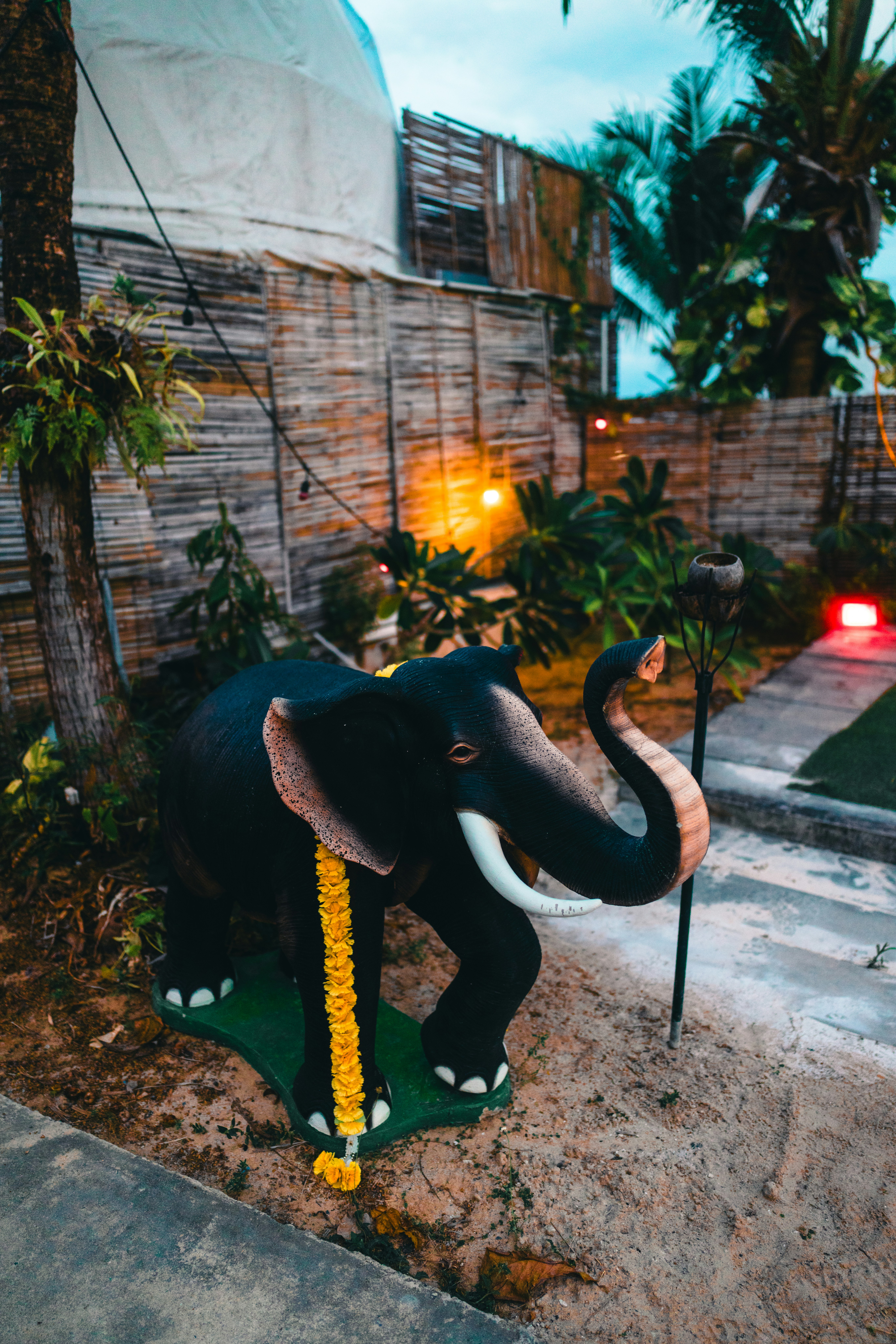 Dusk-lit Elephant Guardian in a Tropical Courtyard