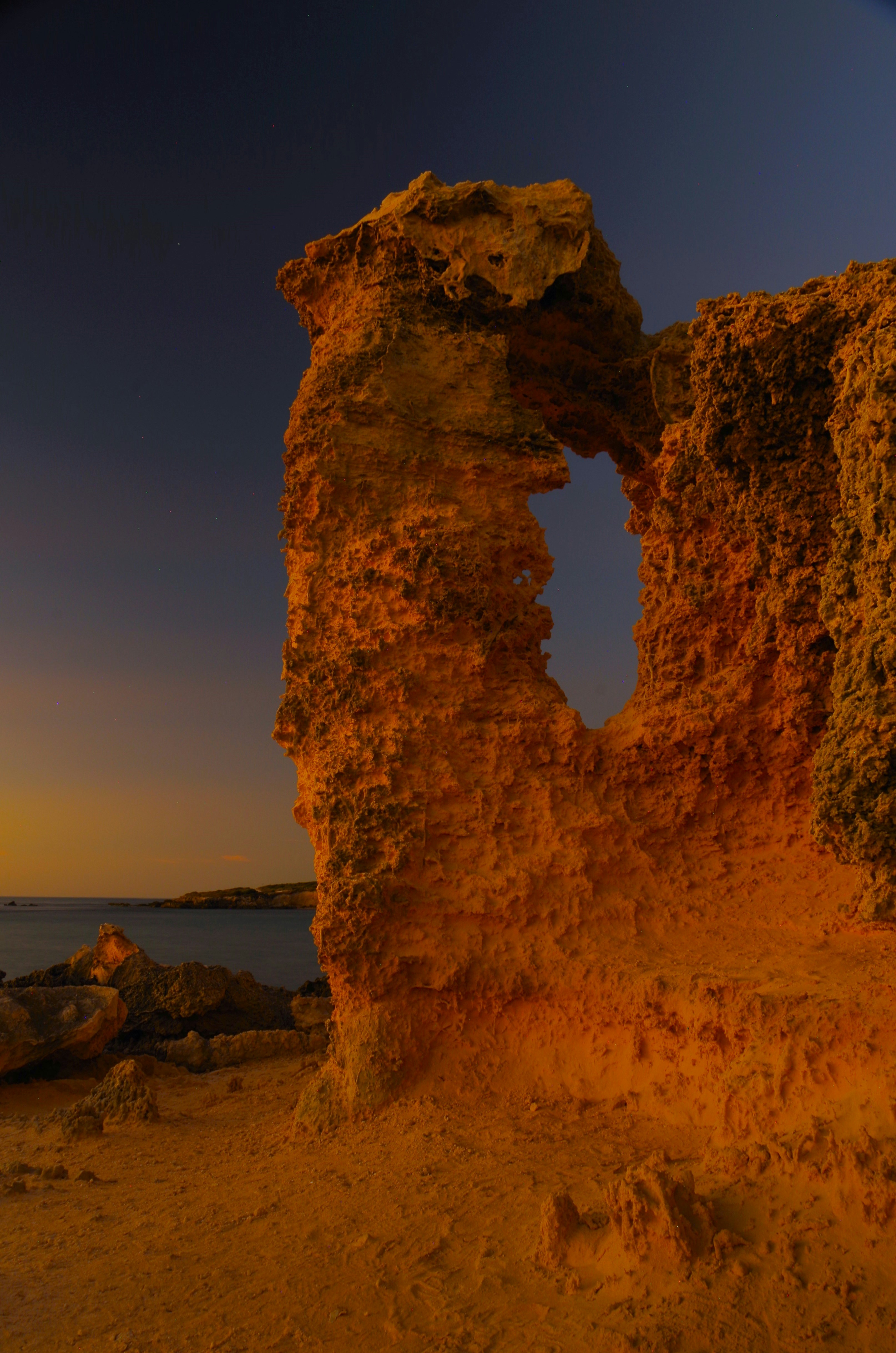 A dramatic rock formation sits at the seashore. photo – Free Beach ...