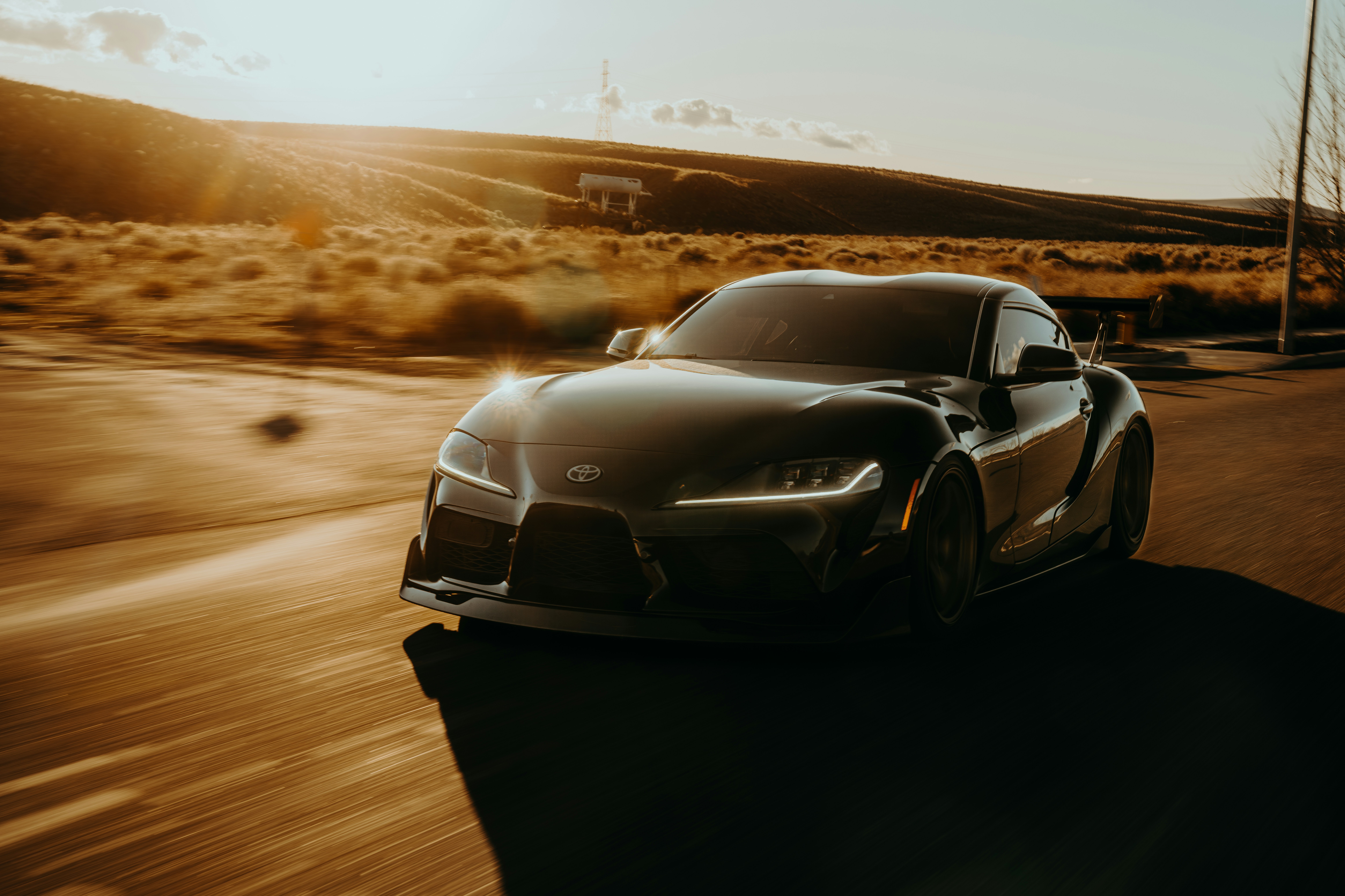 A black toyota supra drives in the sunset. photo – Free Car Image on ...