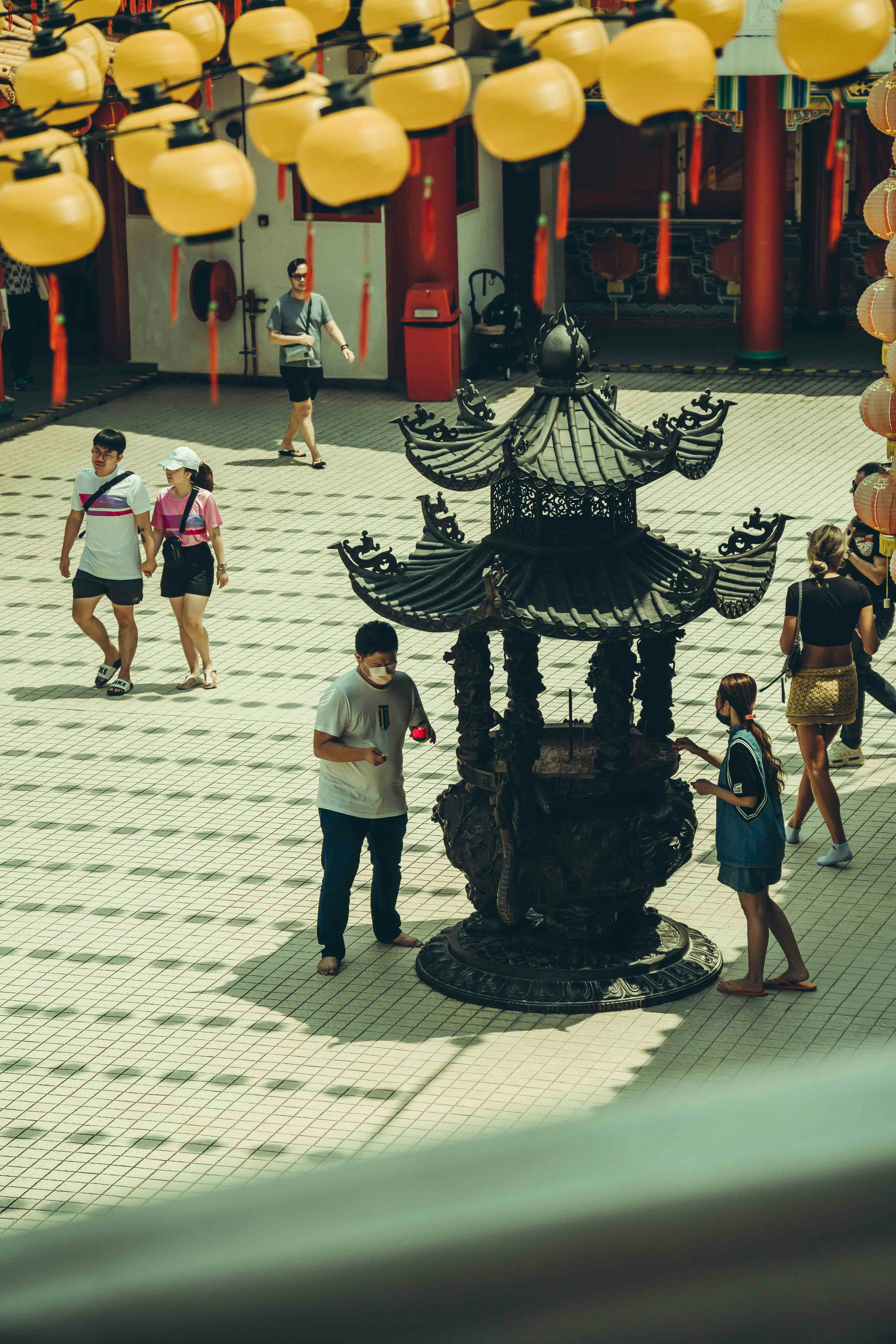 Iron Pagoda Fountain Amid Lanterns in a Temple Courtyard