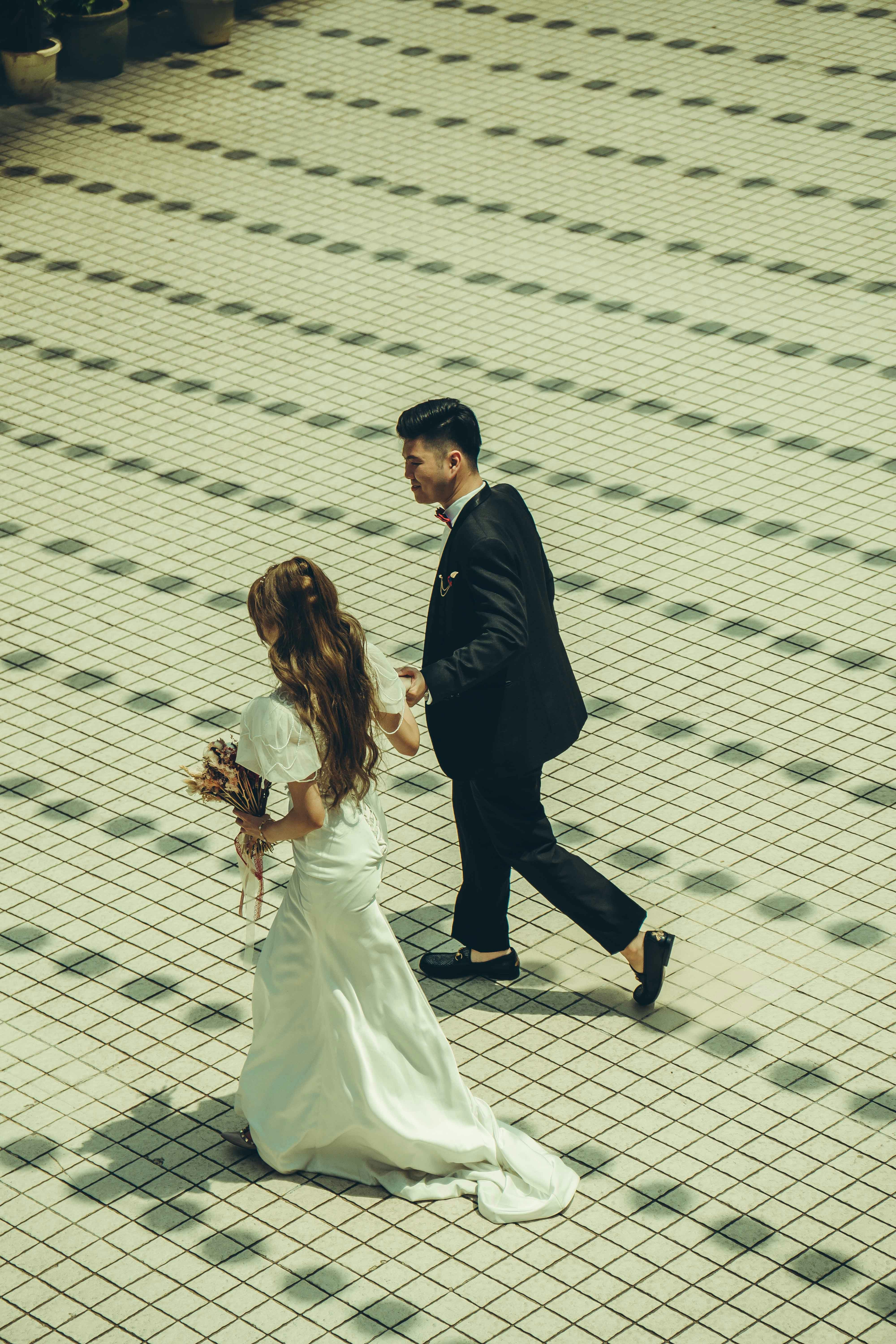 Gridwalk: A Bride and Groom Traversing a Tiled Piazza, Shot from Above
