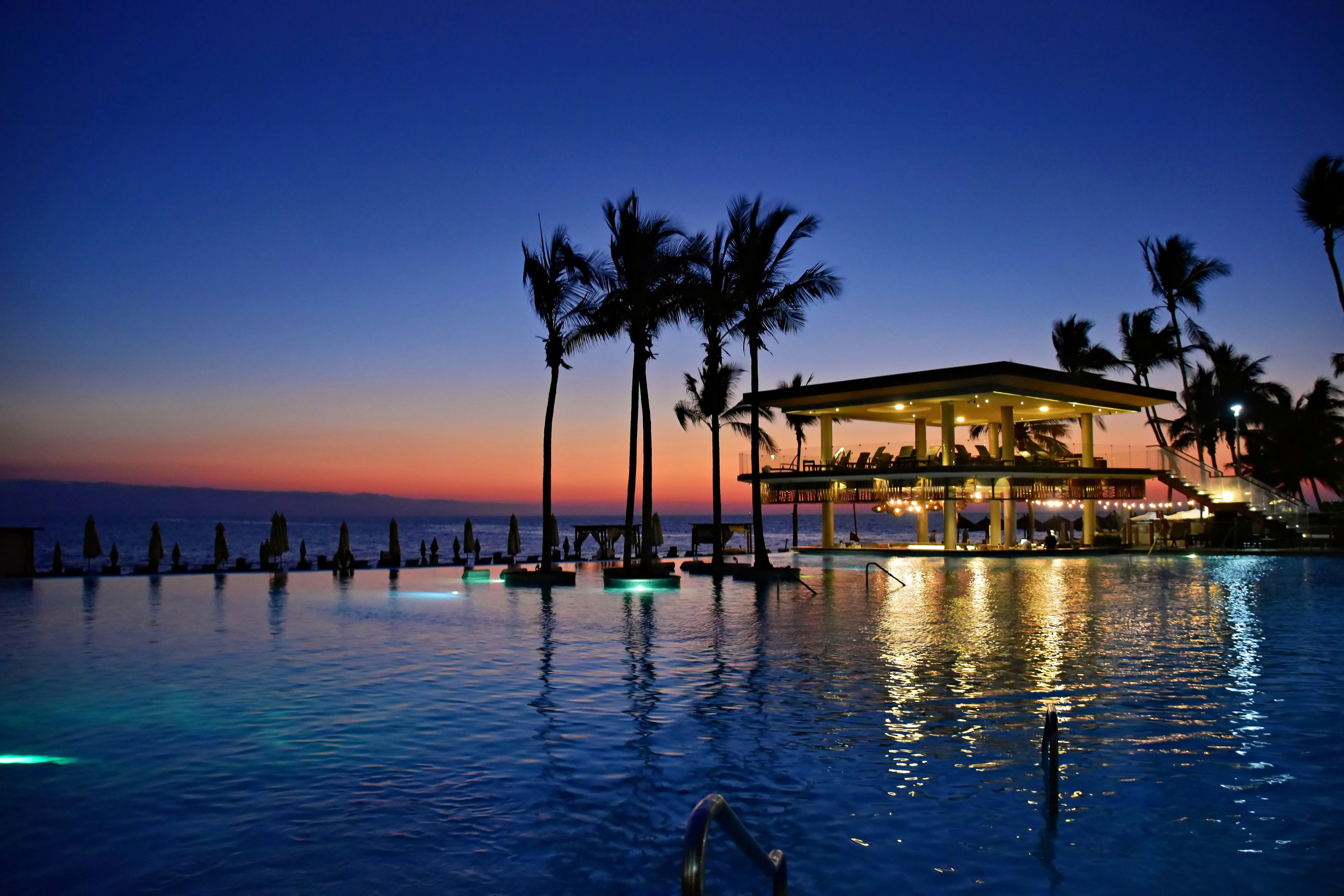 A beautiful resort pool at a tropical sunset. photo – Free Sea Image on ...