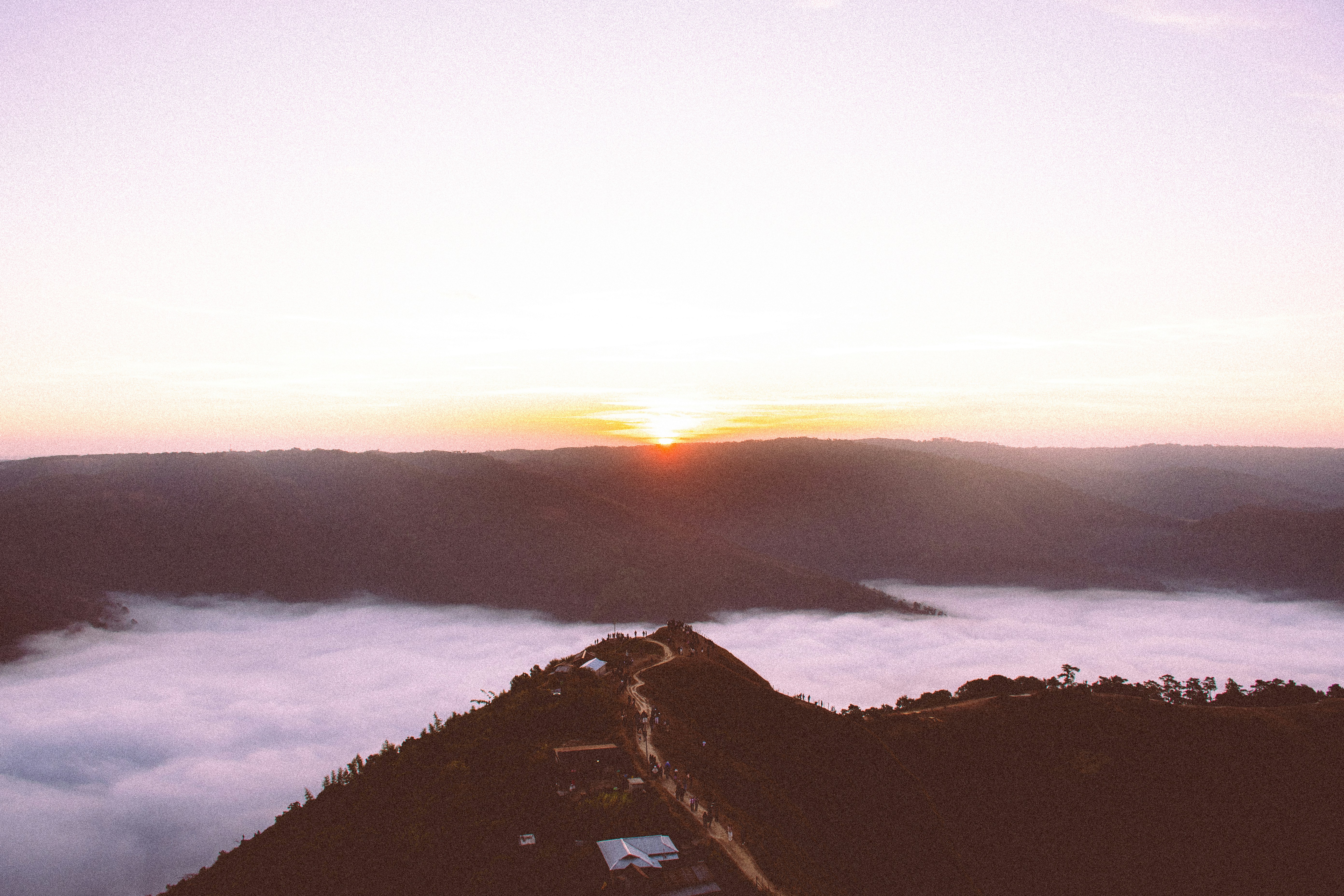 Dawn's Embrace Over Misty Peaks