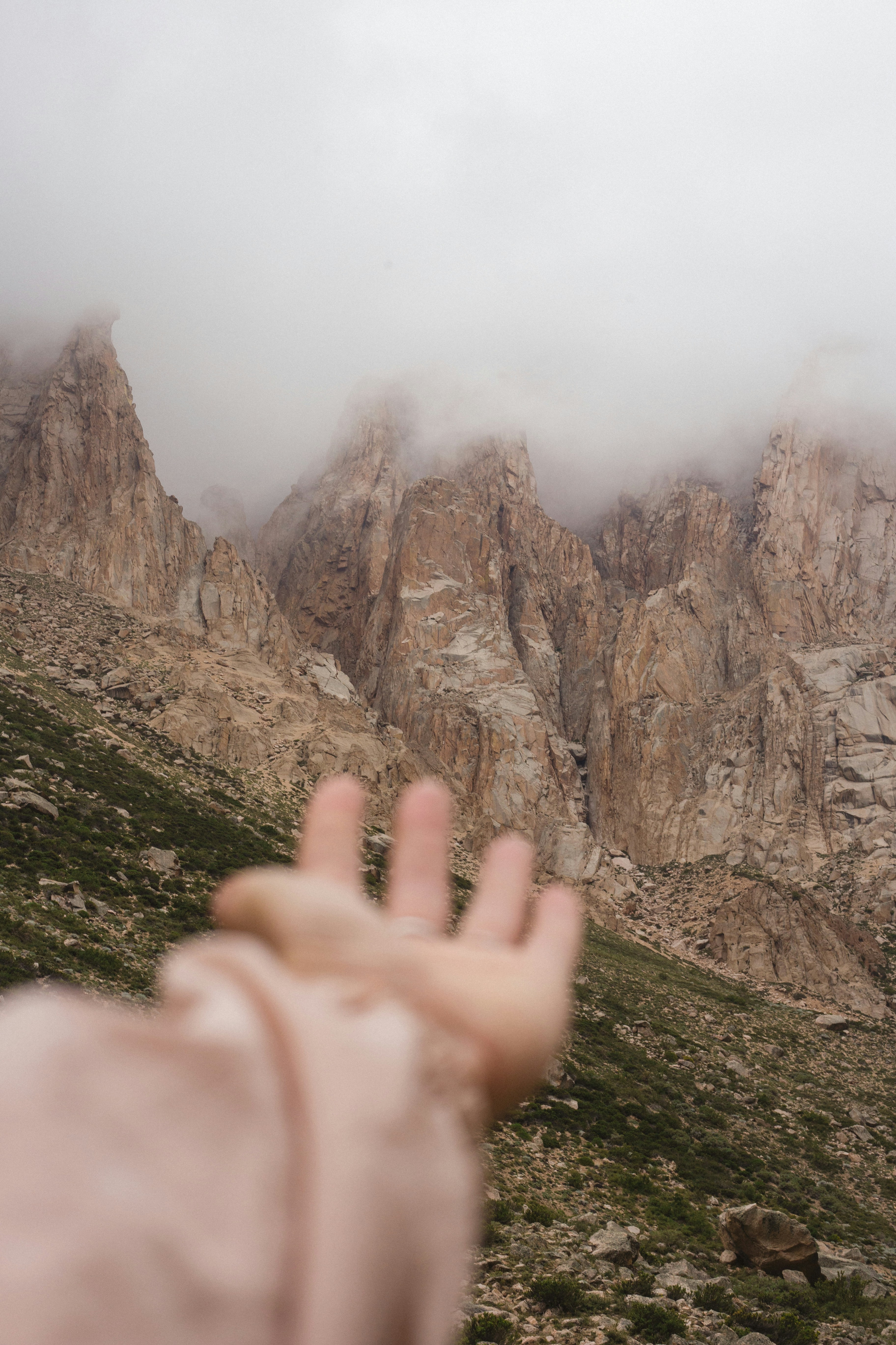 Reaching Toward the Mist: Hands and Alpine Spires
