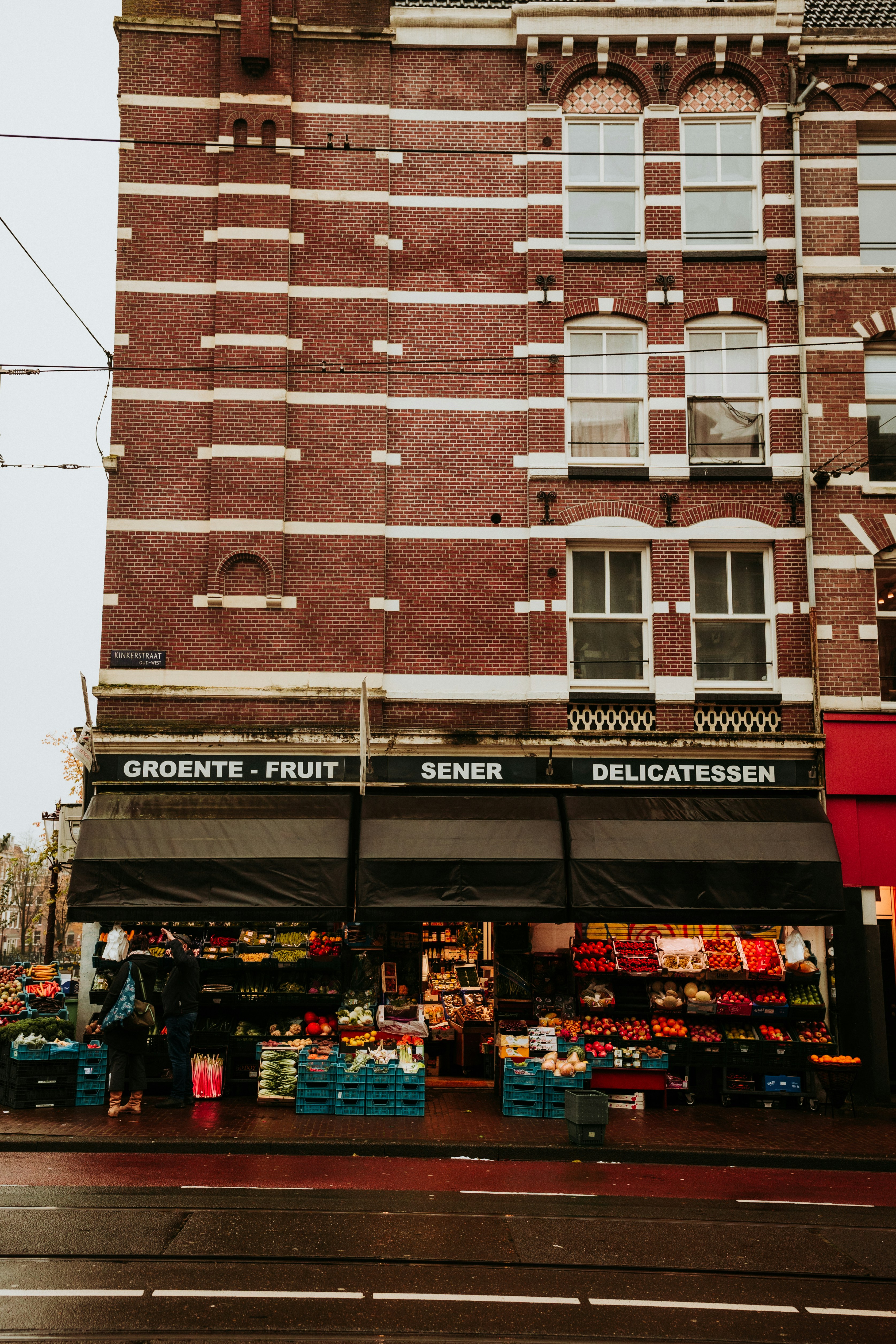 Produce Front Beneath a Dutch Brick Facade