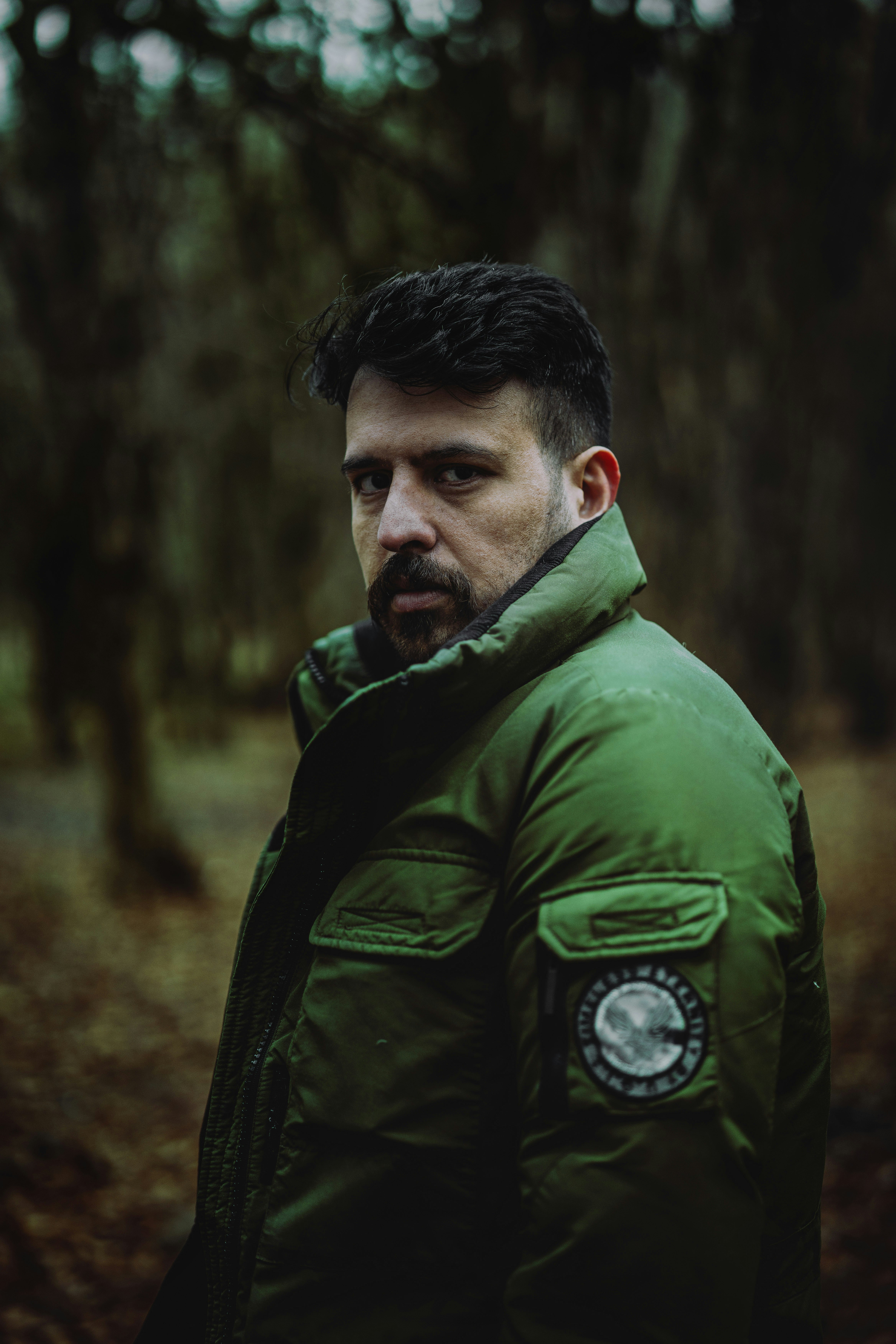Green Jacket, Quiet Forest: A Portrait in Moody Light
