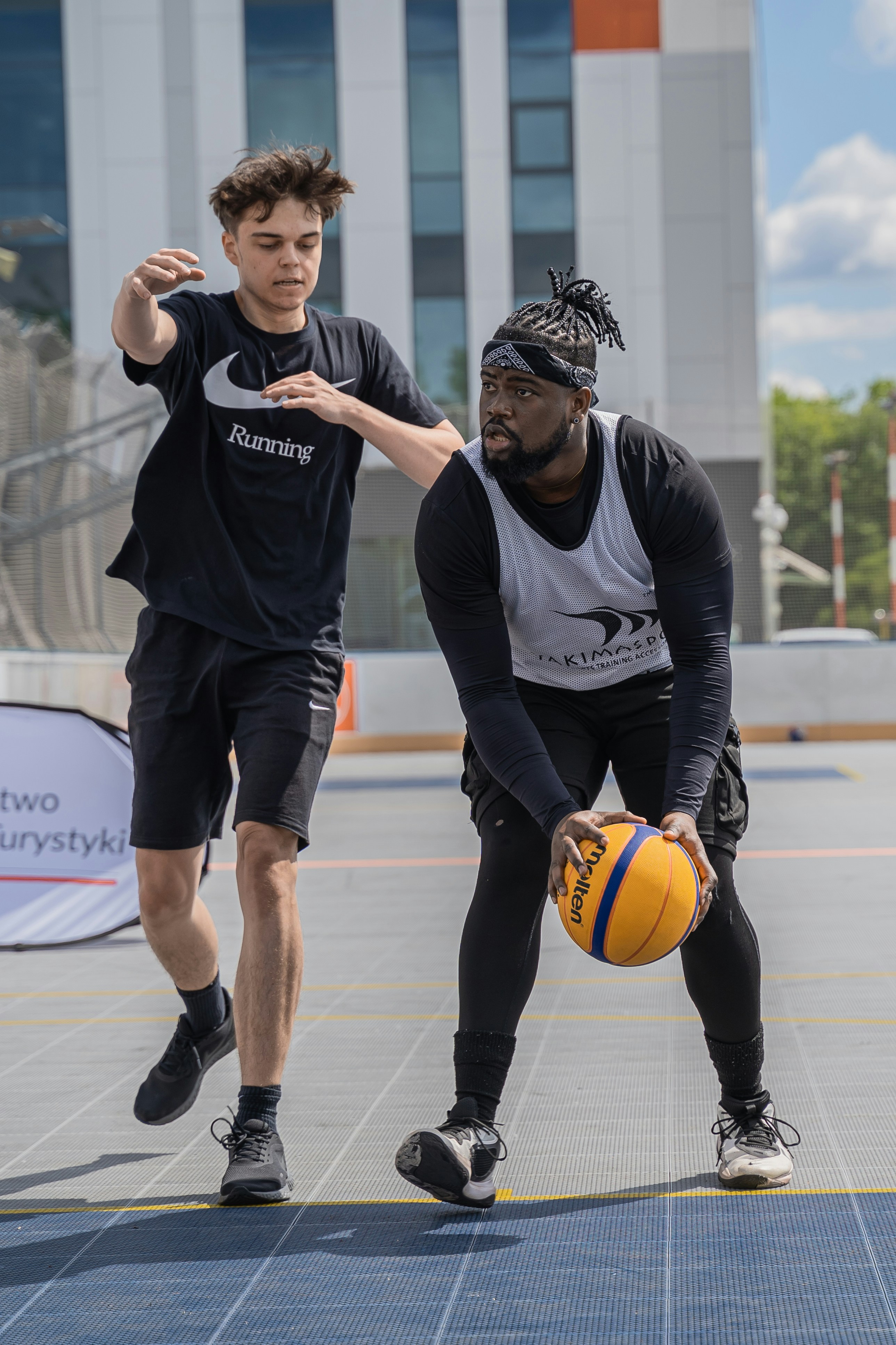 Two men play basketball in a street setting. photo – Free Man Image on ...
