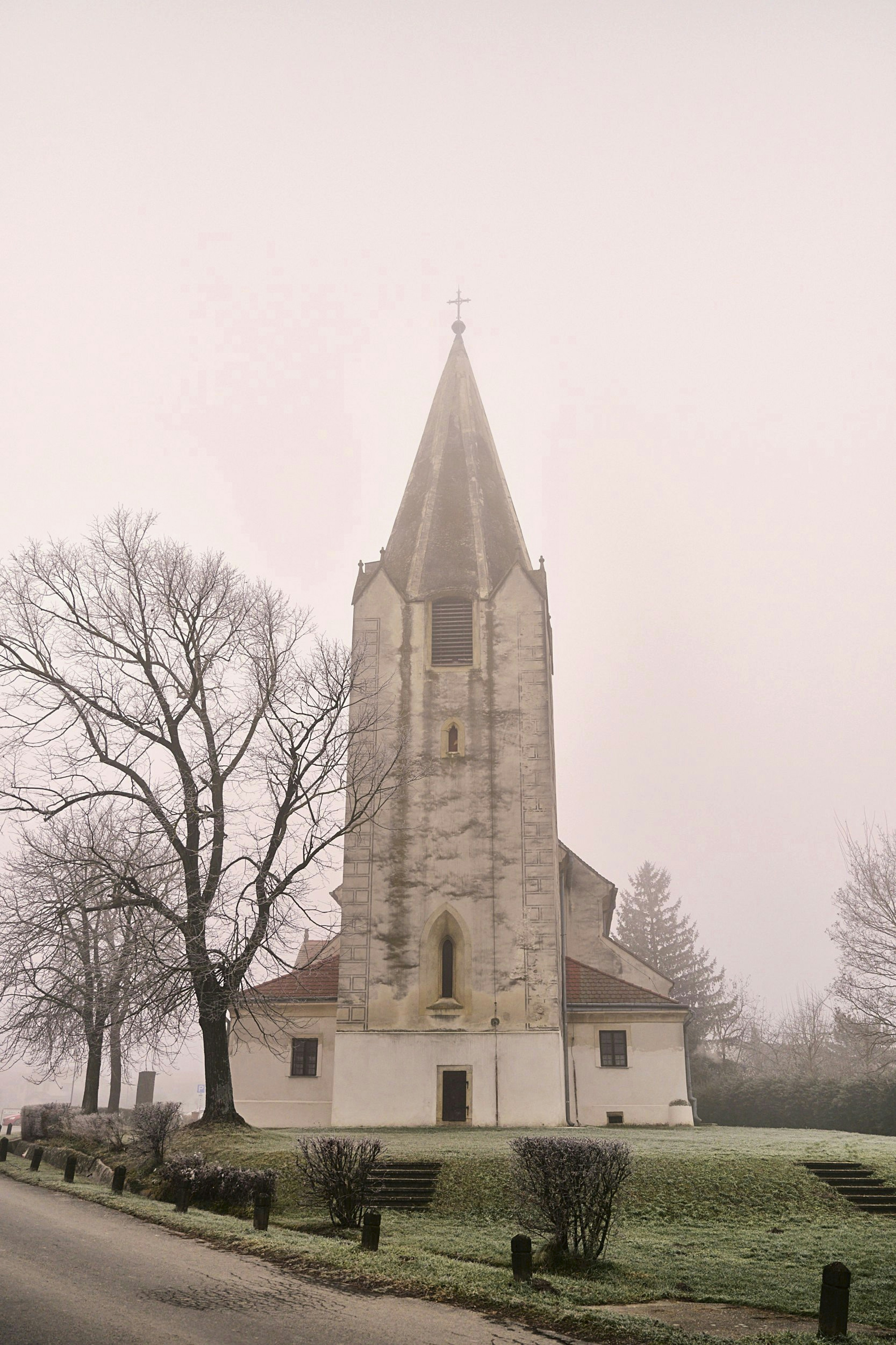 Church tower stands tall in misty landscape. photo – Free Building ...