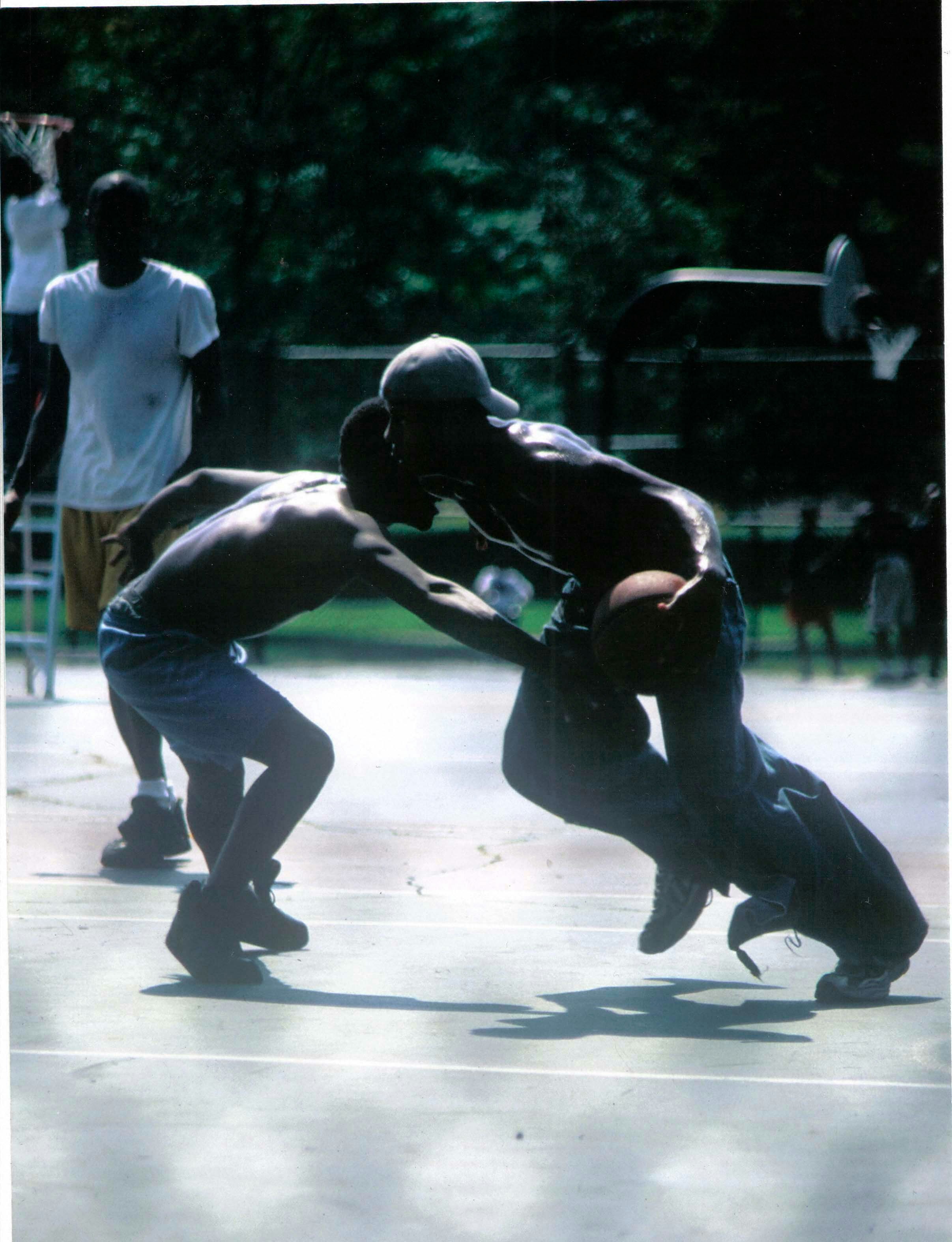 Two men play-fighting outdoors on a court. photo – Free Man Image on ...