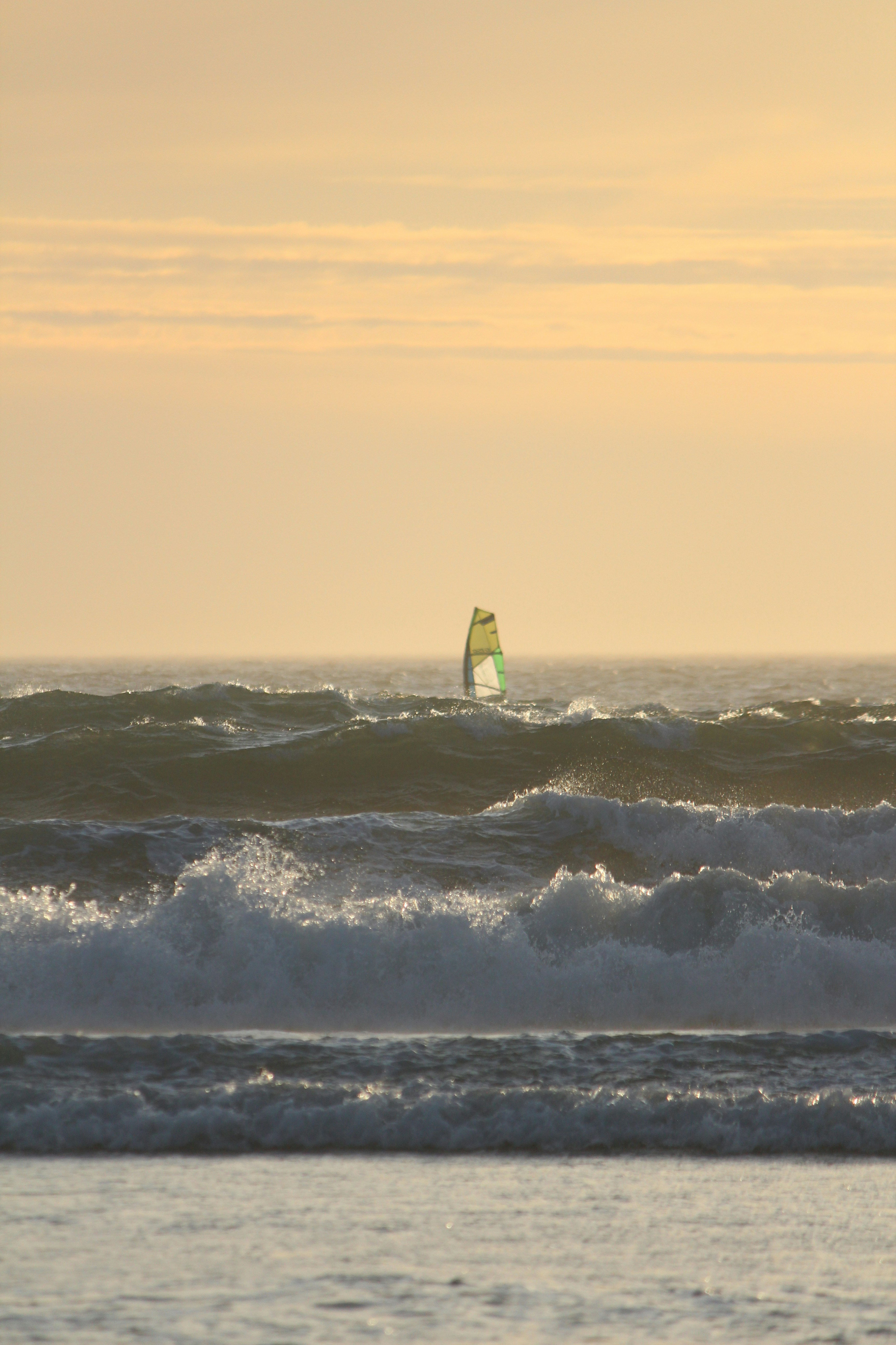 Windsurfer on a choppy ocean at sunset. photo – Free Sea Image on Unsplash