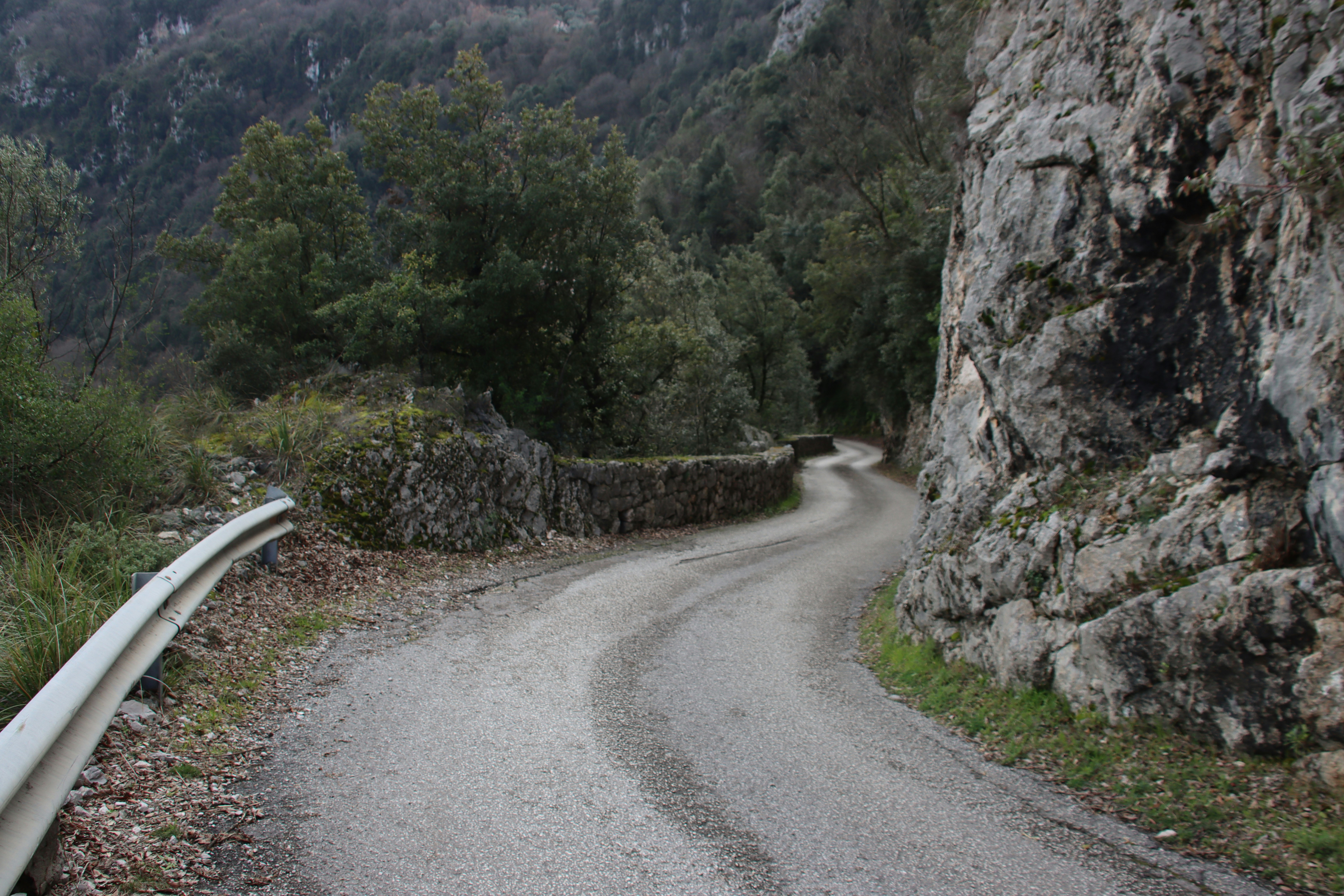 A winding, narrow road curves through the mountains. photo – Free Road ...