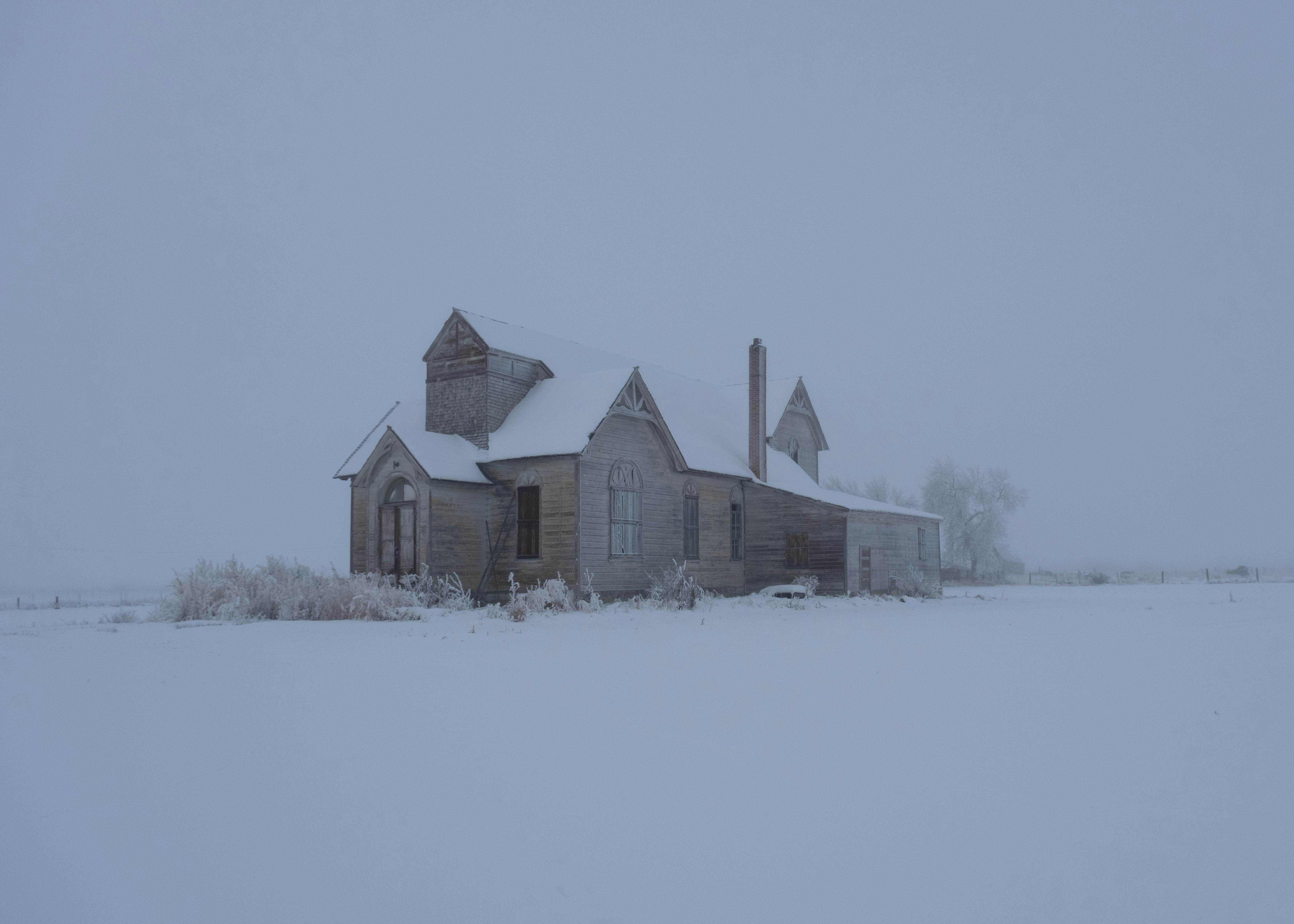 Weathered Chapel in a Quiet White Field