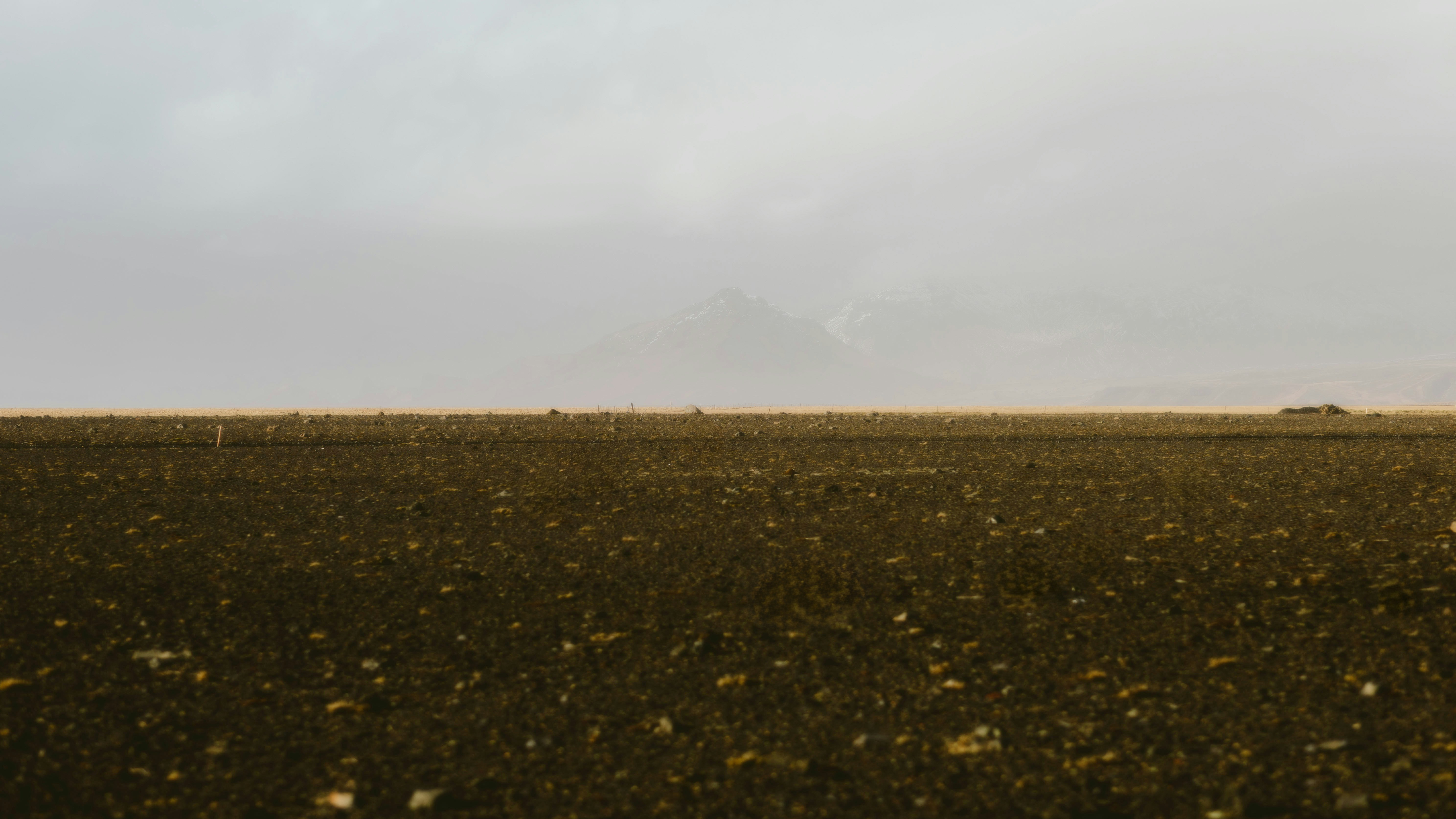 A vast, barren field stretches toward the horizon. photo – Free Land ...