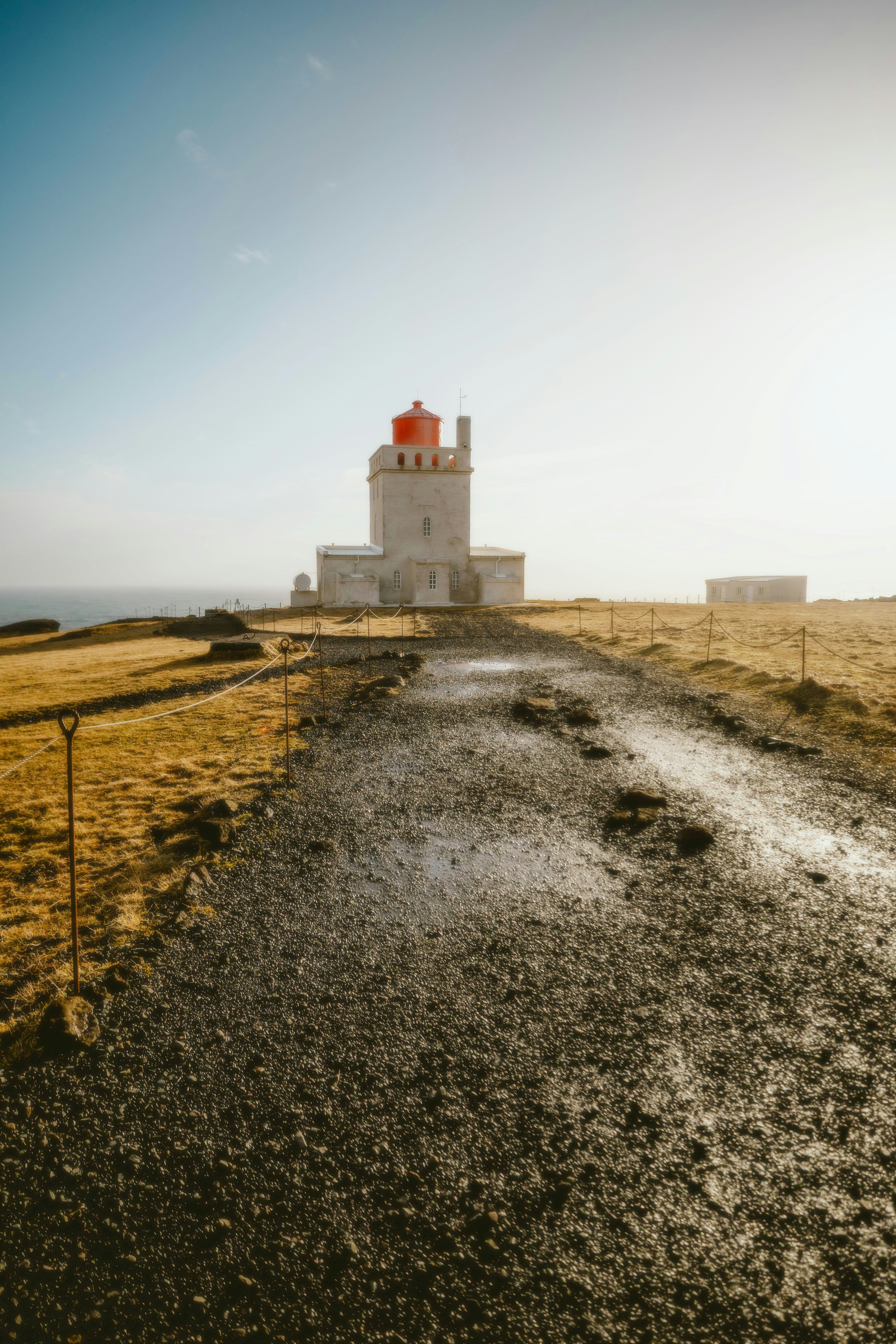 Gravel Path to a Red-Topped Lighthouse at Golden Hour