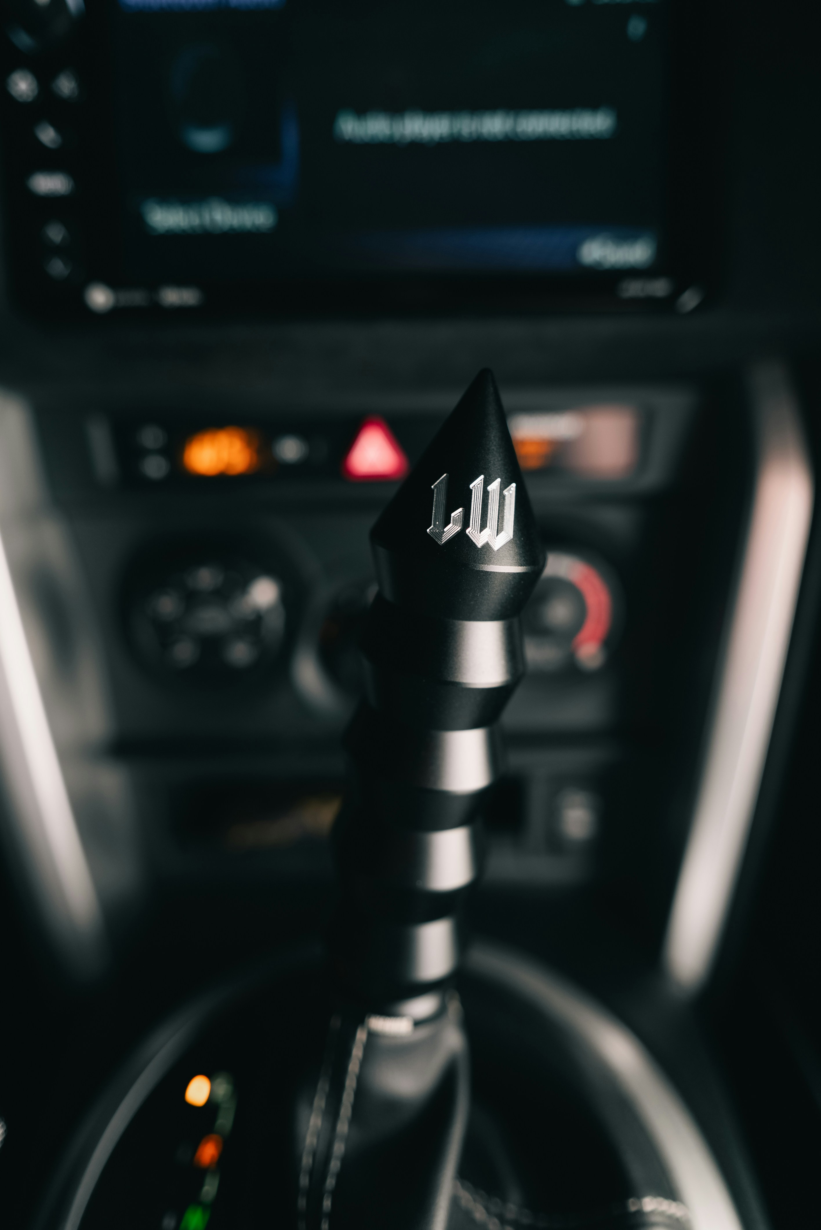 Coiled Crown on a Gear Lever: A Macro Portrait in a Dim Car Cabin