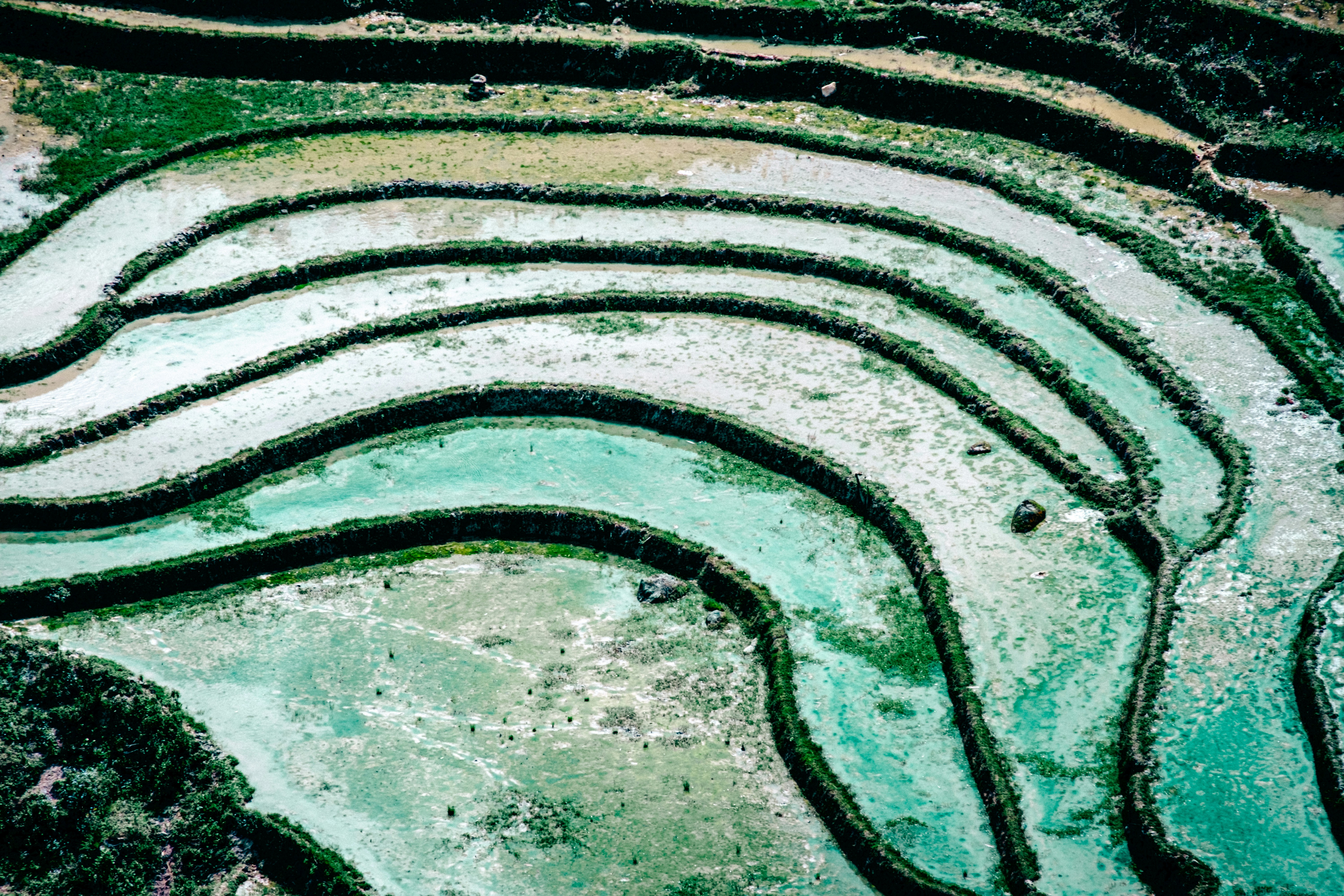 Terraced mineral pools: an abstract canyon of turquoise echoes
