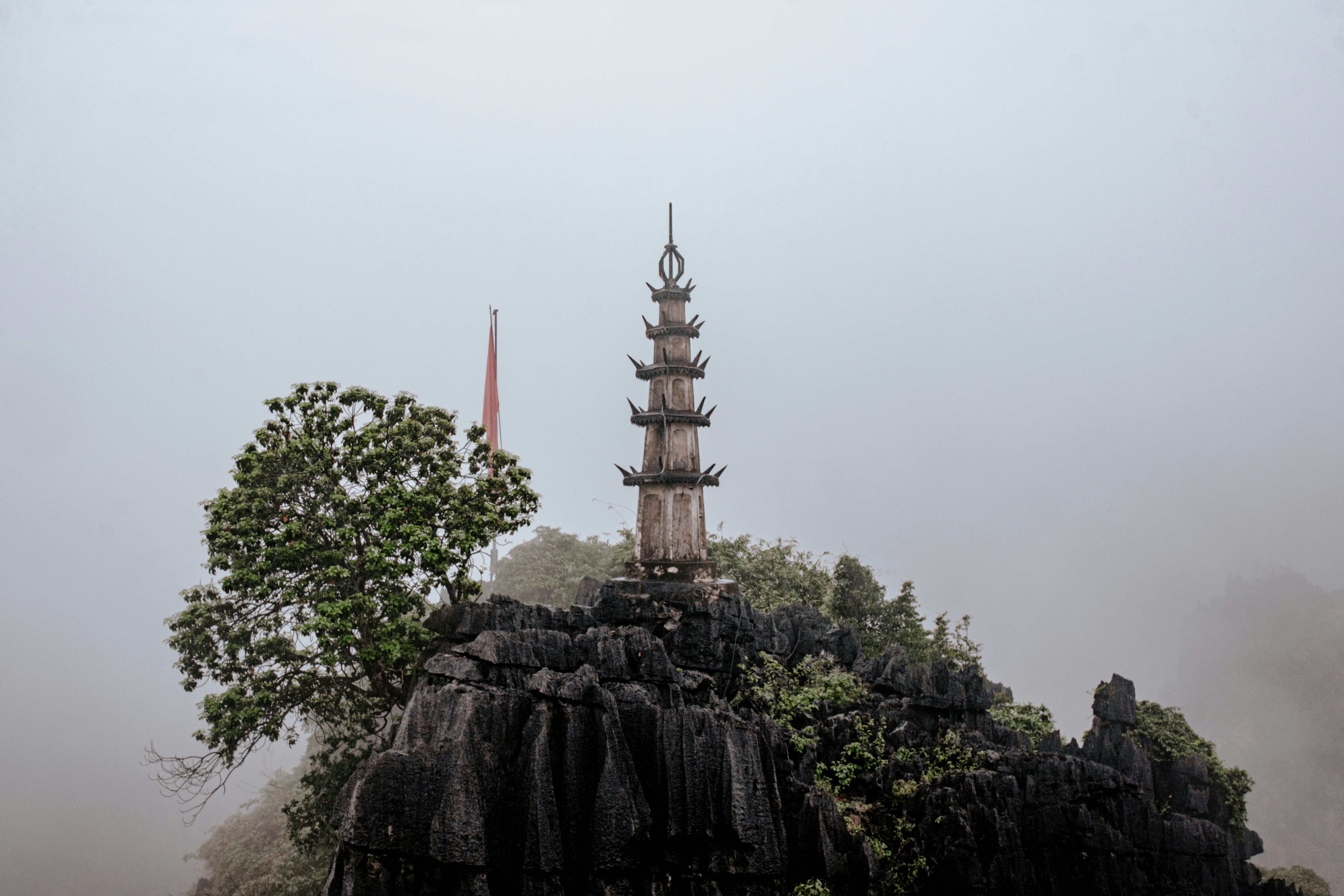 Mist-Guarded Summit: A Stone Pagoda Rising from Veiled Cliffs